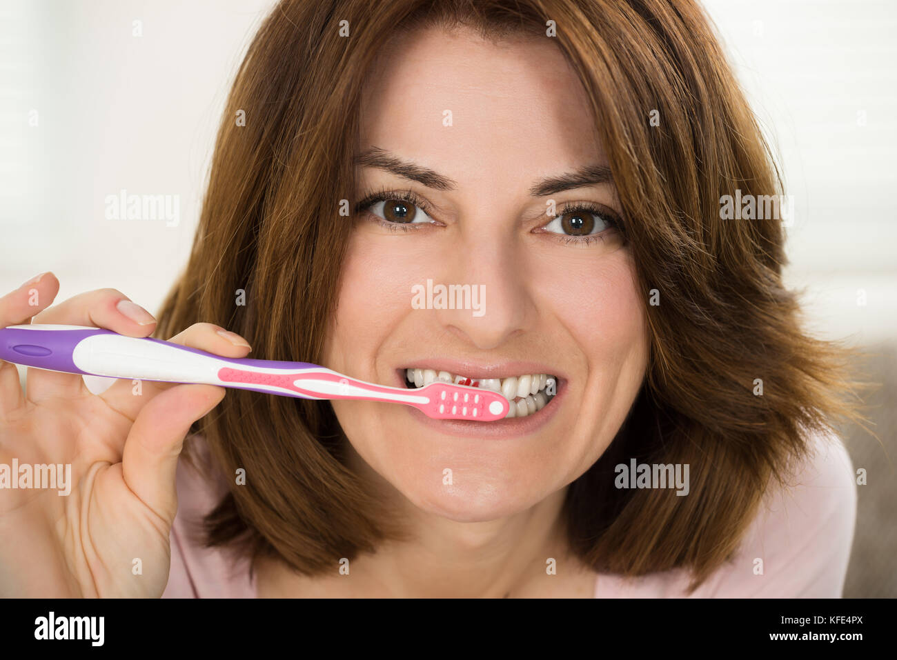 Young Woman Brushing Her Teeth With Toothbrush At Home Stock Photo - Alamy