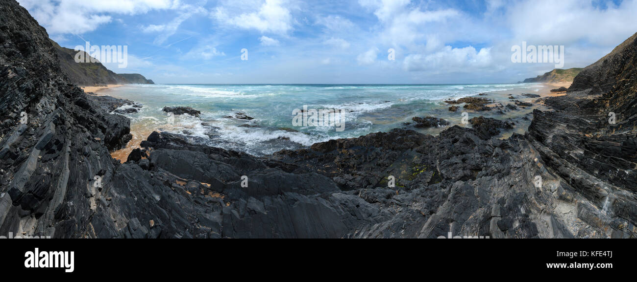 Storm on Castelejo beach with black schist stone cliffs and yelloy sand ...