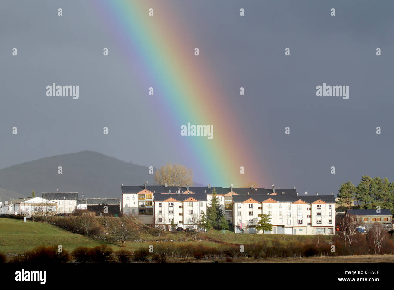 Rainbow over houses Stock Photo - Alamy
