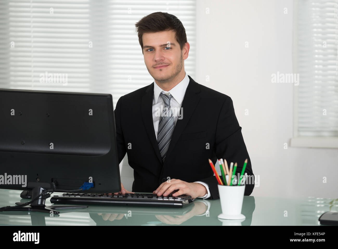 Young Businessman Working On Computer In Office Stock Photo - Alamy