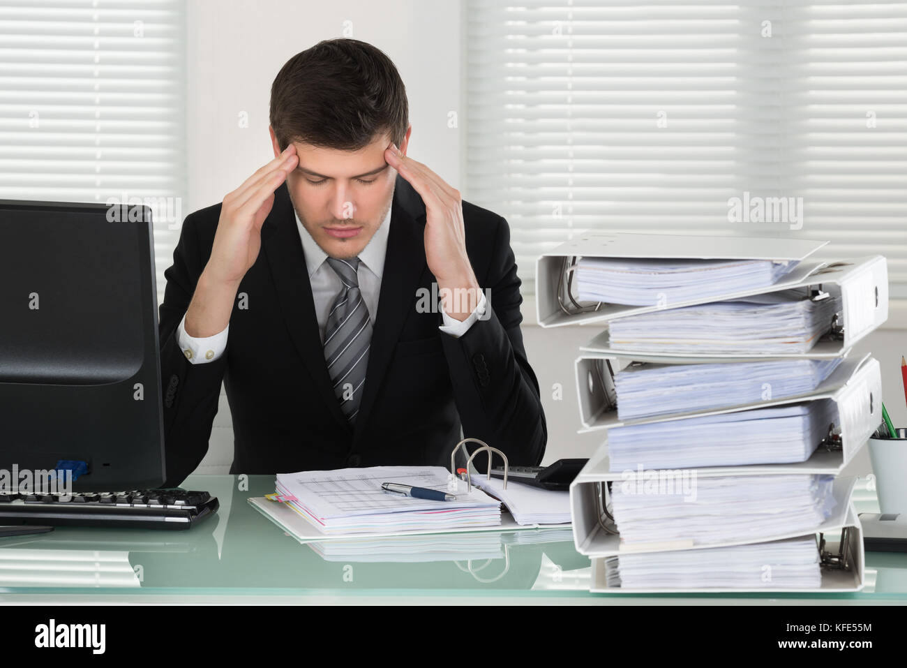 Businessman Suffering From Headache With Invoice On Desk Stock Photo ...