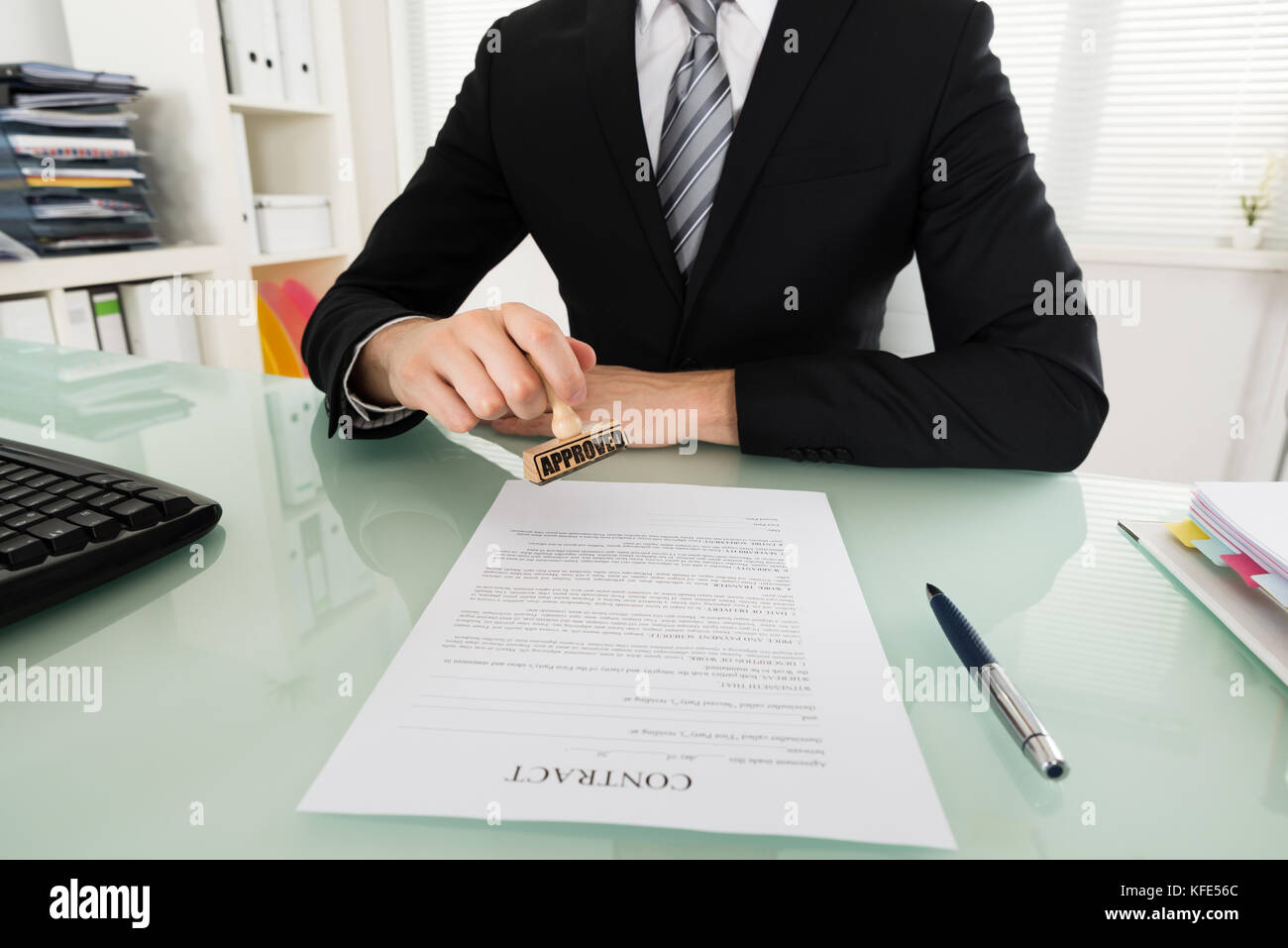 Close-up Of Businessman Hand Stamping Approved On Contract Paper Stock ...