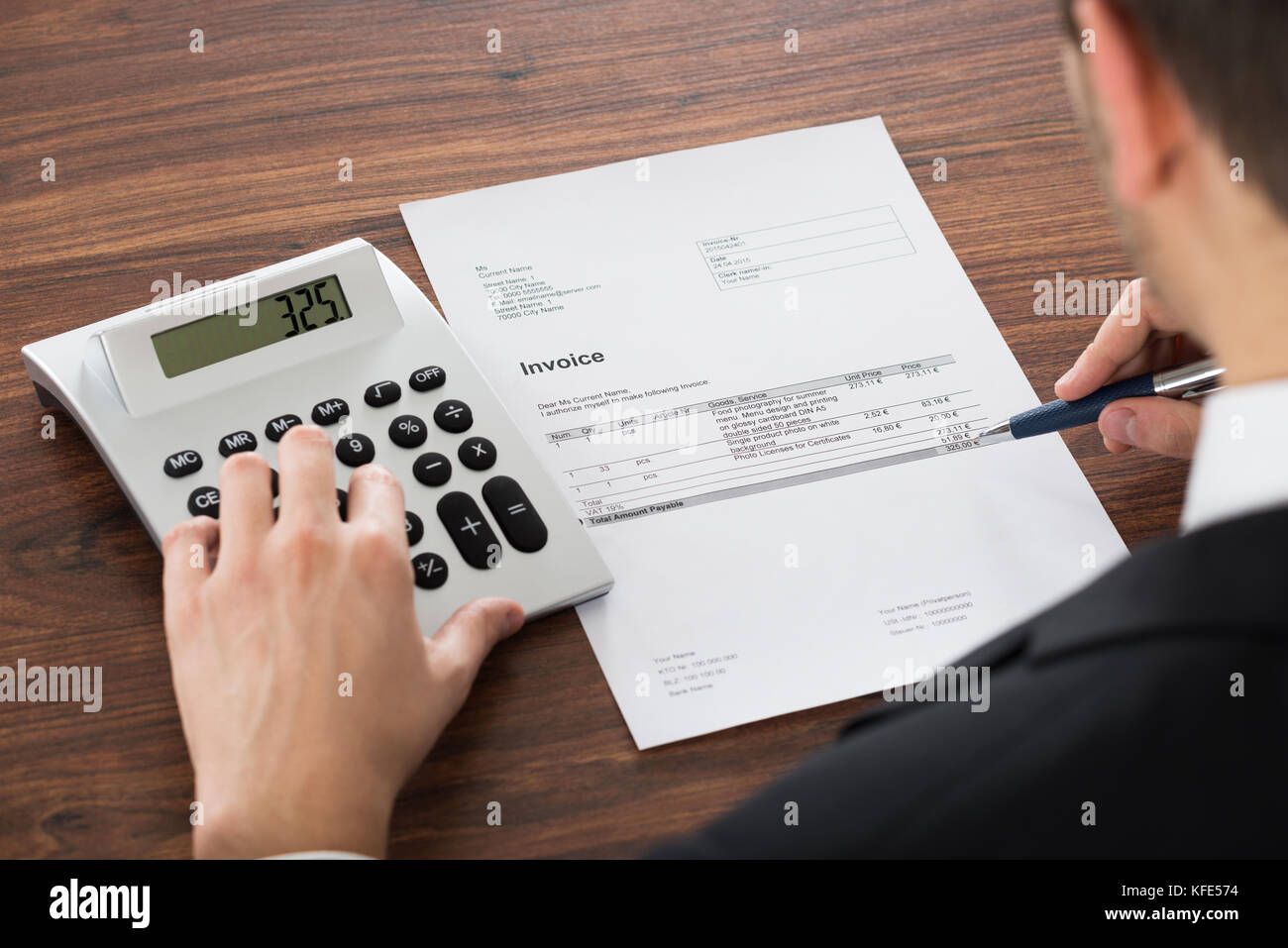 Close-up Photo Of Young Businessman Calculating Bill Stock Photo - Alamy