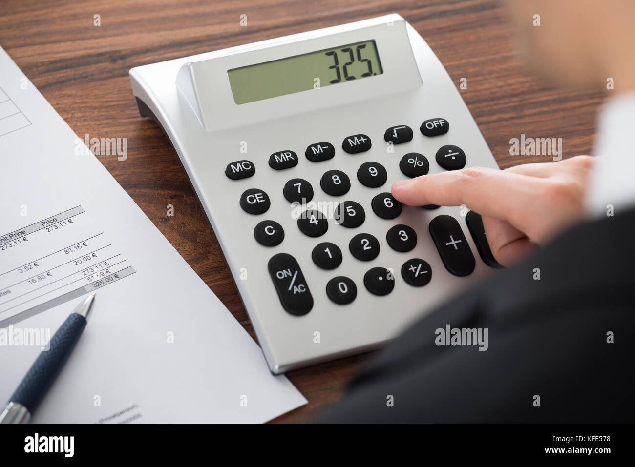 Close-up Photo Of Young Businessman Calculating Bill Stock Photo - Alamy