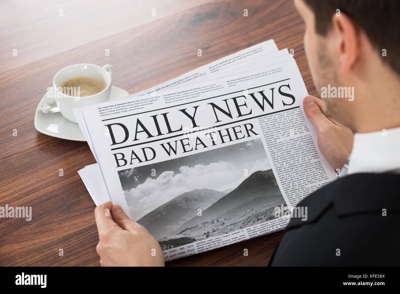Close-up Of Young Businessman Reading Weather News On Newspaper Stock ...