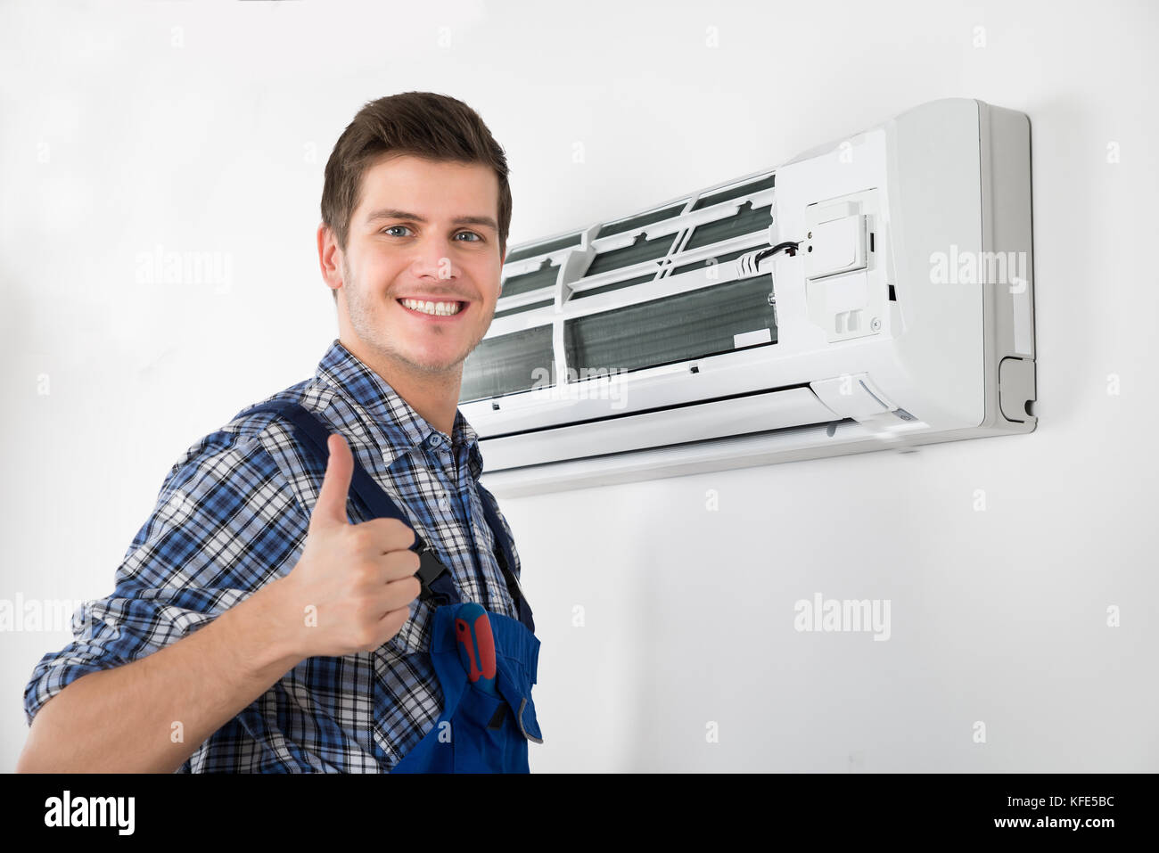 Young Happy Male Technician Gesturing Thumb Up Stock Photo - Alamy