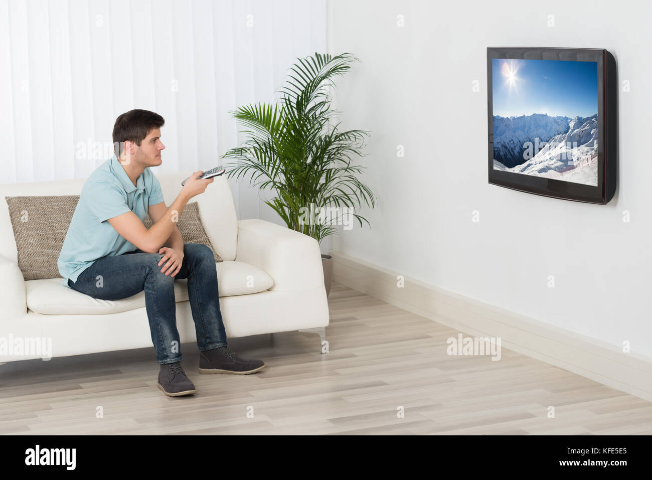 Photo Of Young Man Watching Television At Home Stock Photo - Alamy