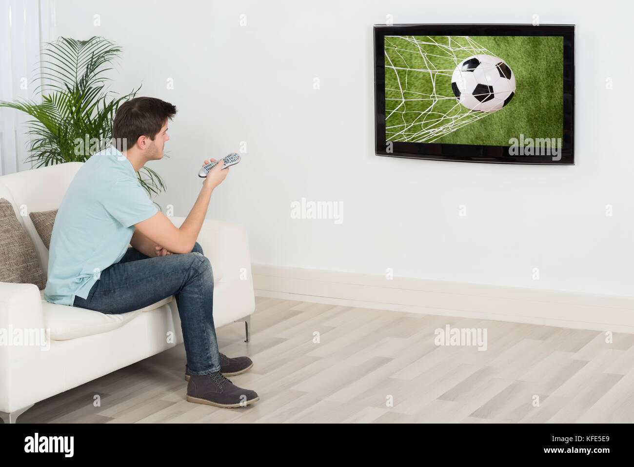 Man watching football home sitting hi-res stock photography and images ...