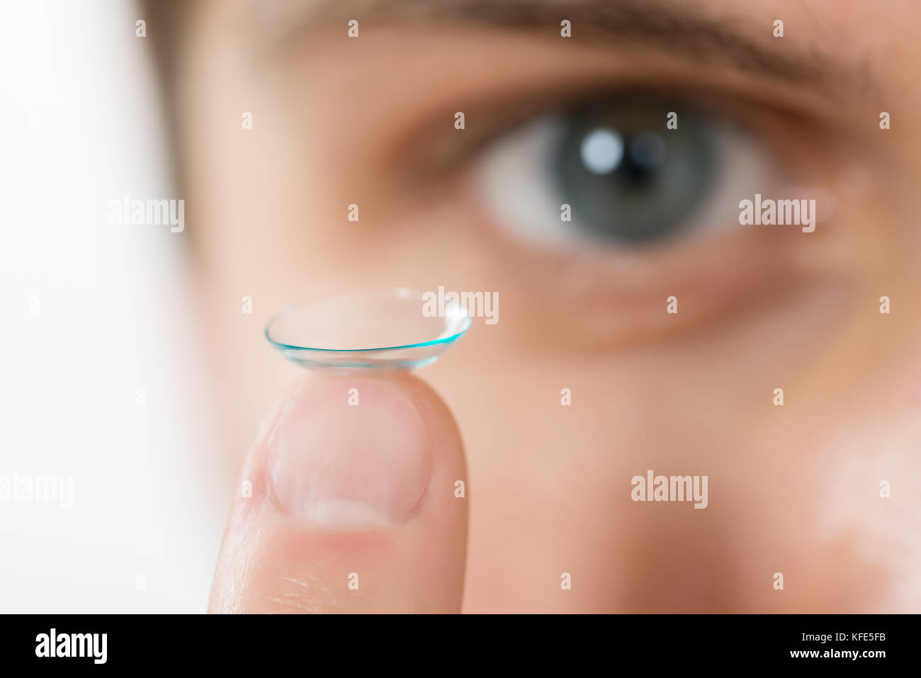 Close-up Of Young Man Holding Contact Lens On Finger Stock Photo - Alamy