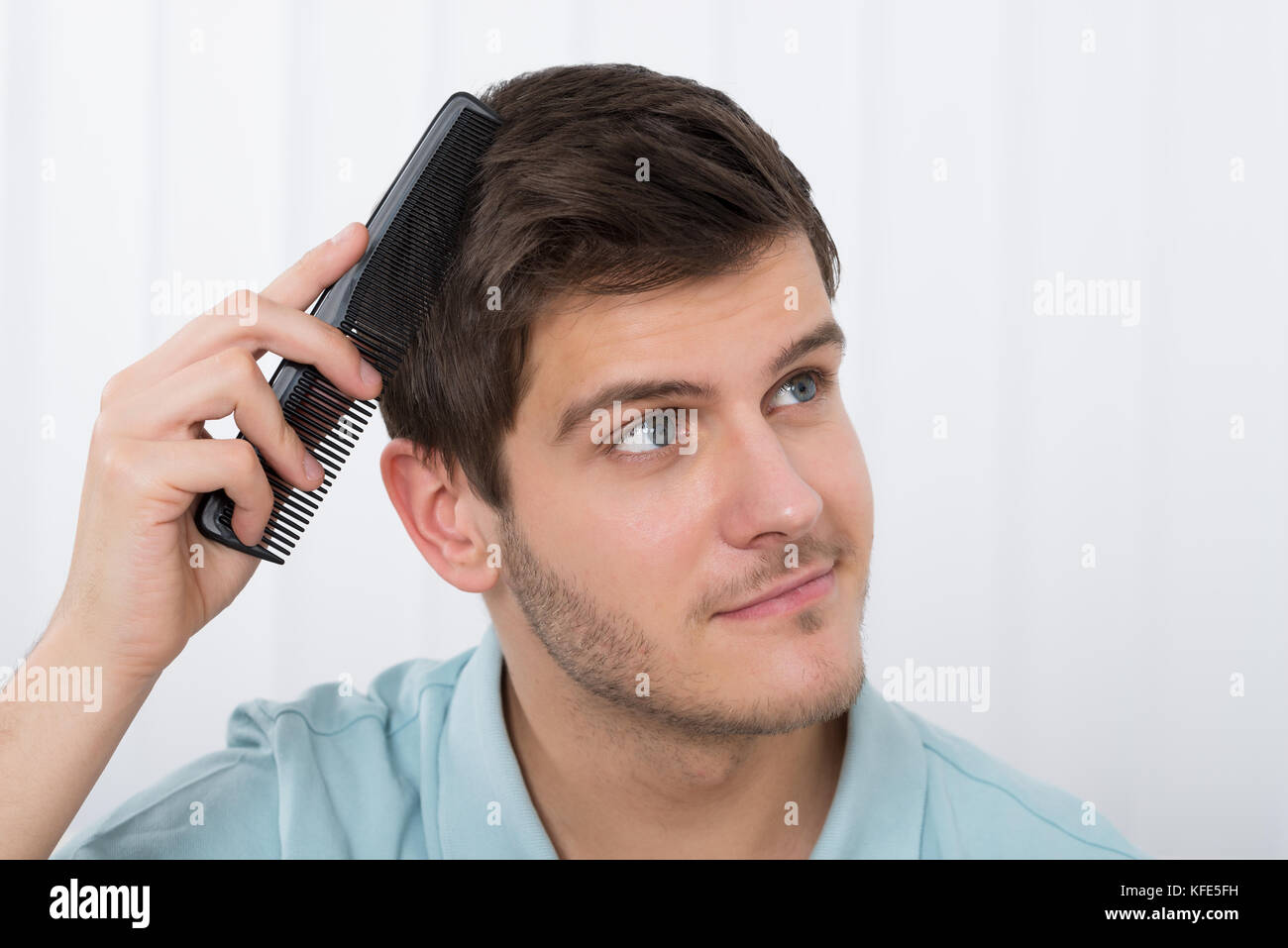 Close-up Of Young Man Combing His Hair With Comb Stock Photo - Alamy
