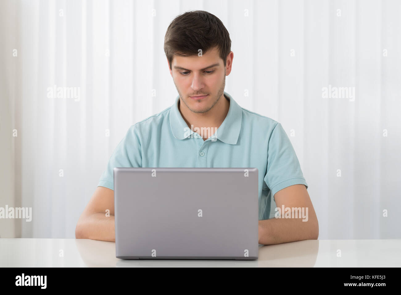 Young man laptop sofa hi-res stock photography and images - Alamy