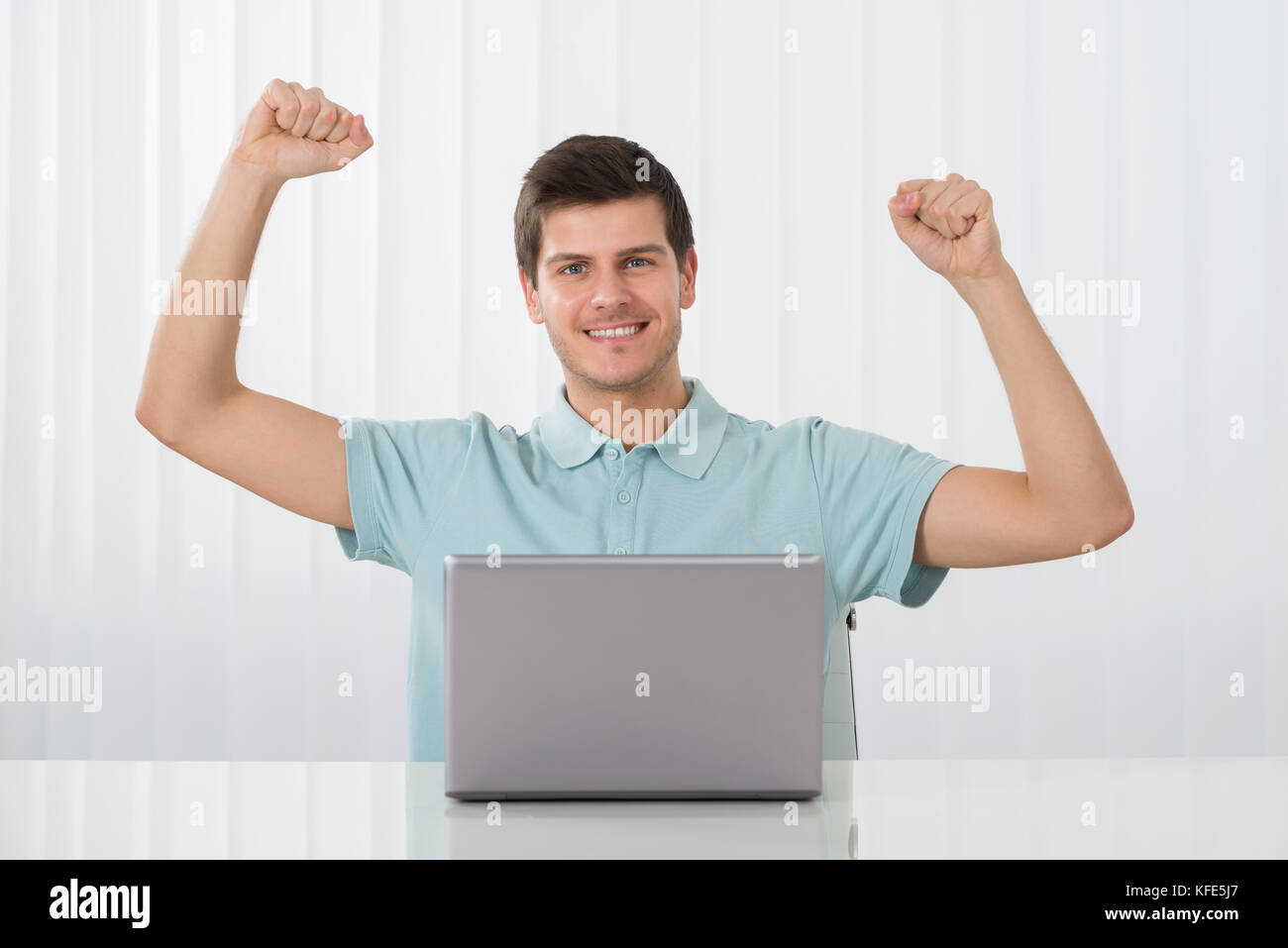 Happy man celebrating work hi-res stock photography and images - Alamy