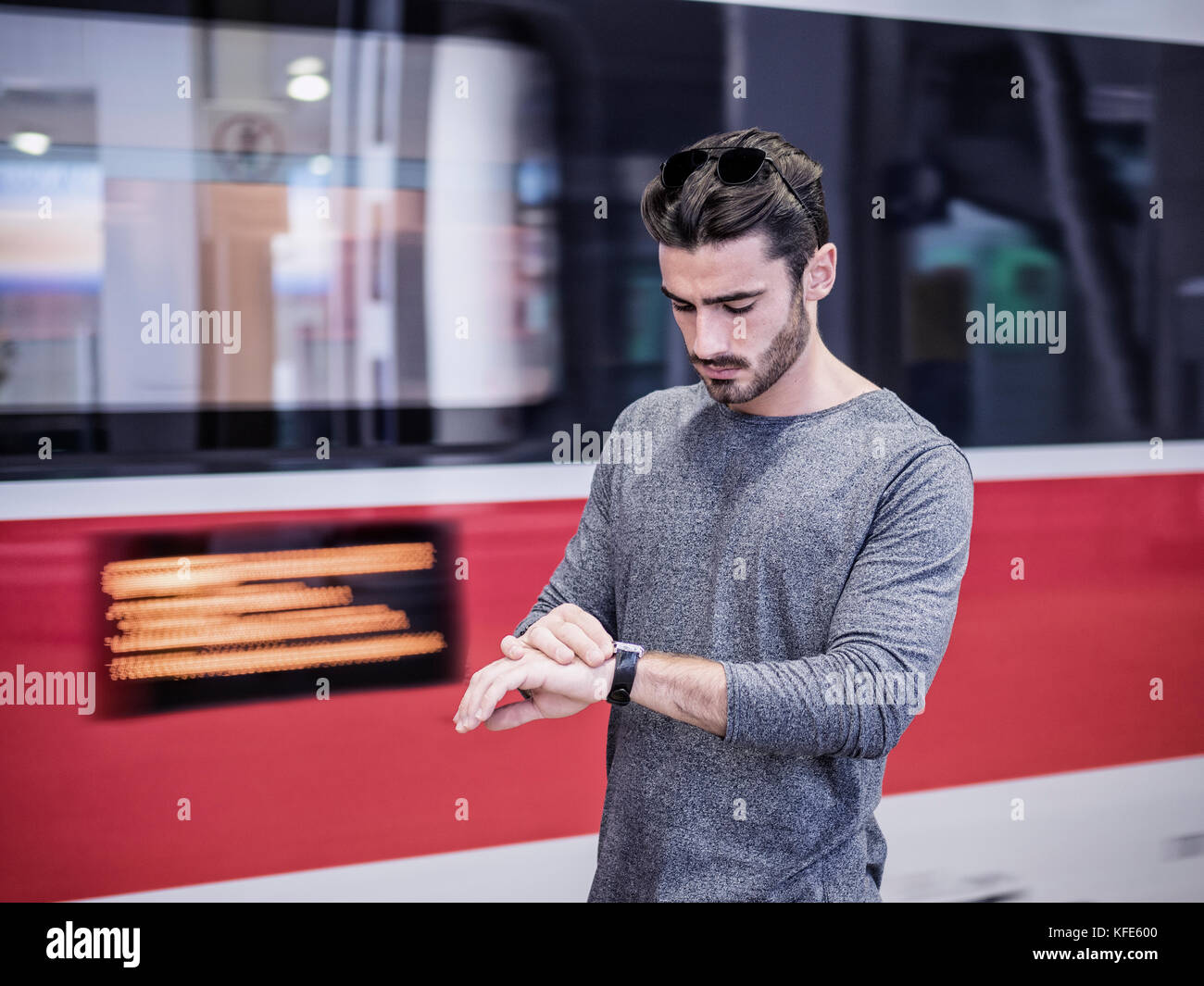 Handsome young male traveler in train station Stock Photo - Alamy