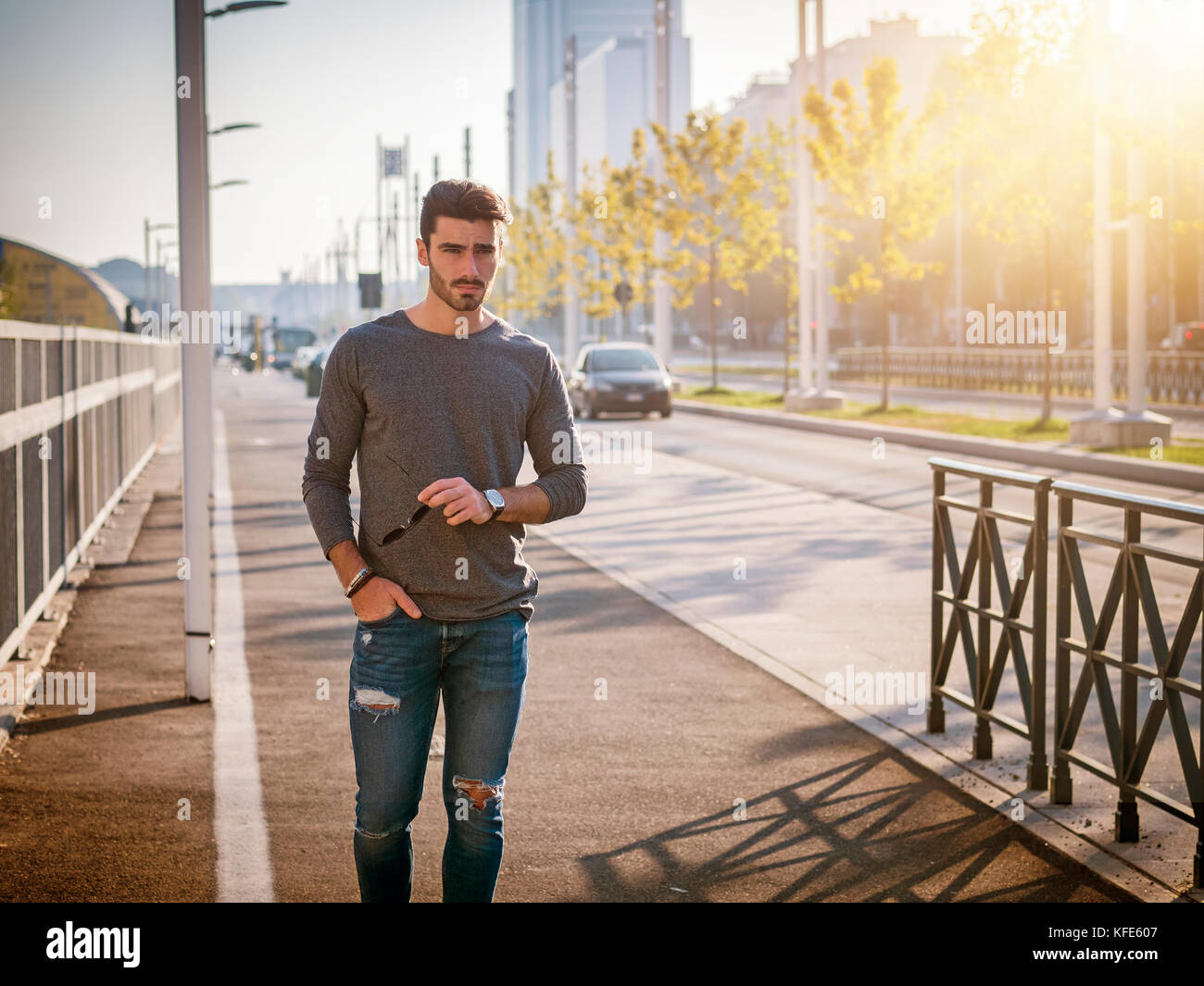 Attractive young man portrait in city street Stock Photo - Alamy