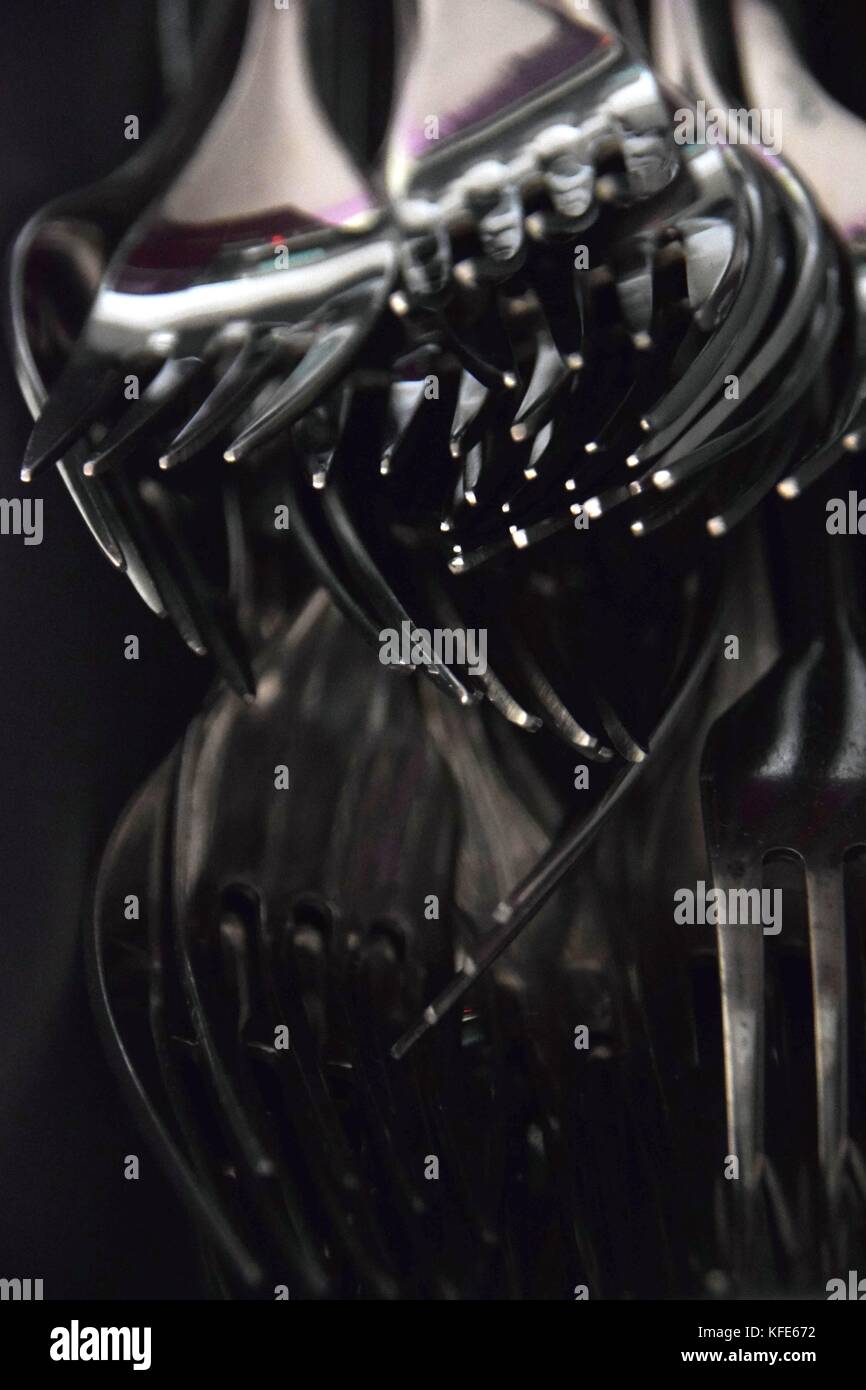 stainless steel forks with reflections, abstract stacked forks in a ...