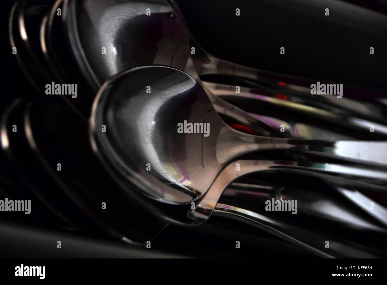 abstract stacked spoons in a cutlery rack Stock Photo - Alamy