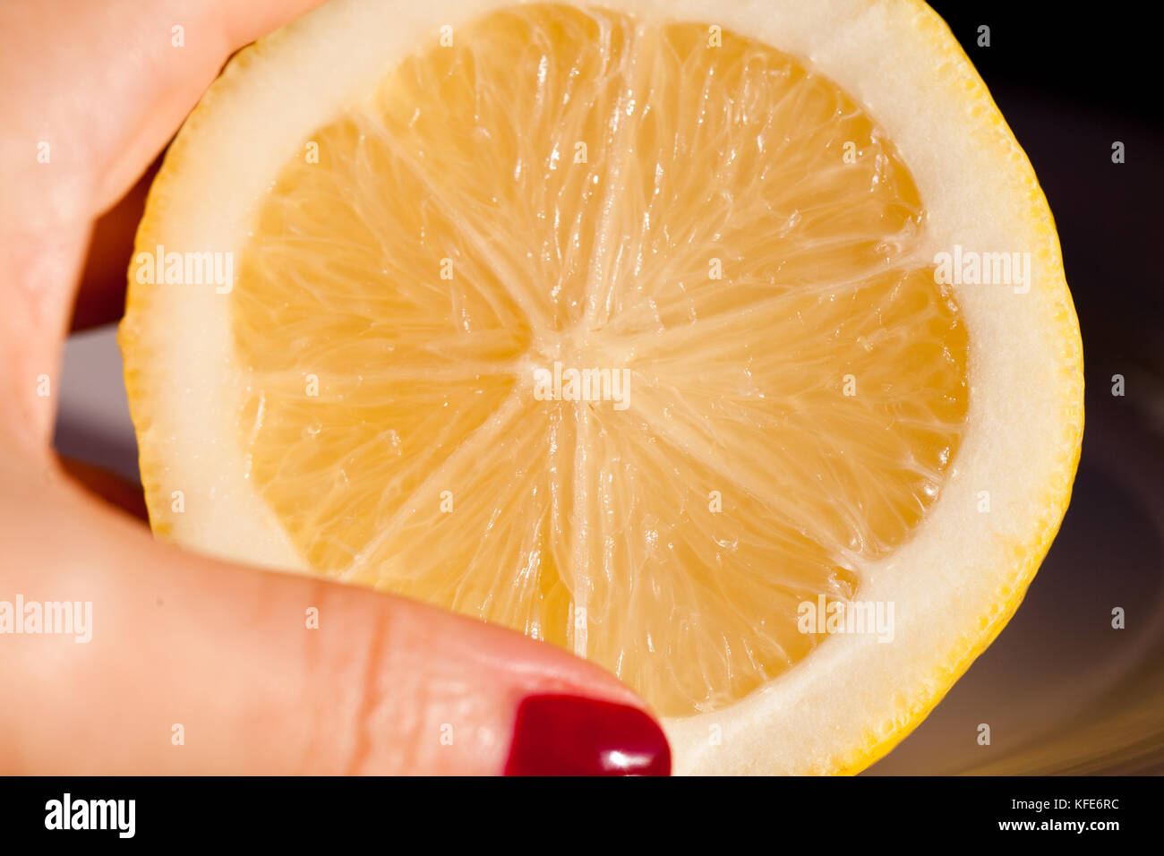 hand holding half lemon Stock Photo - Alamy