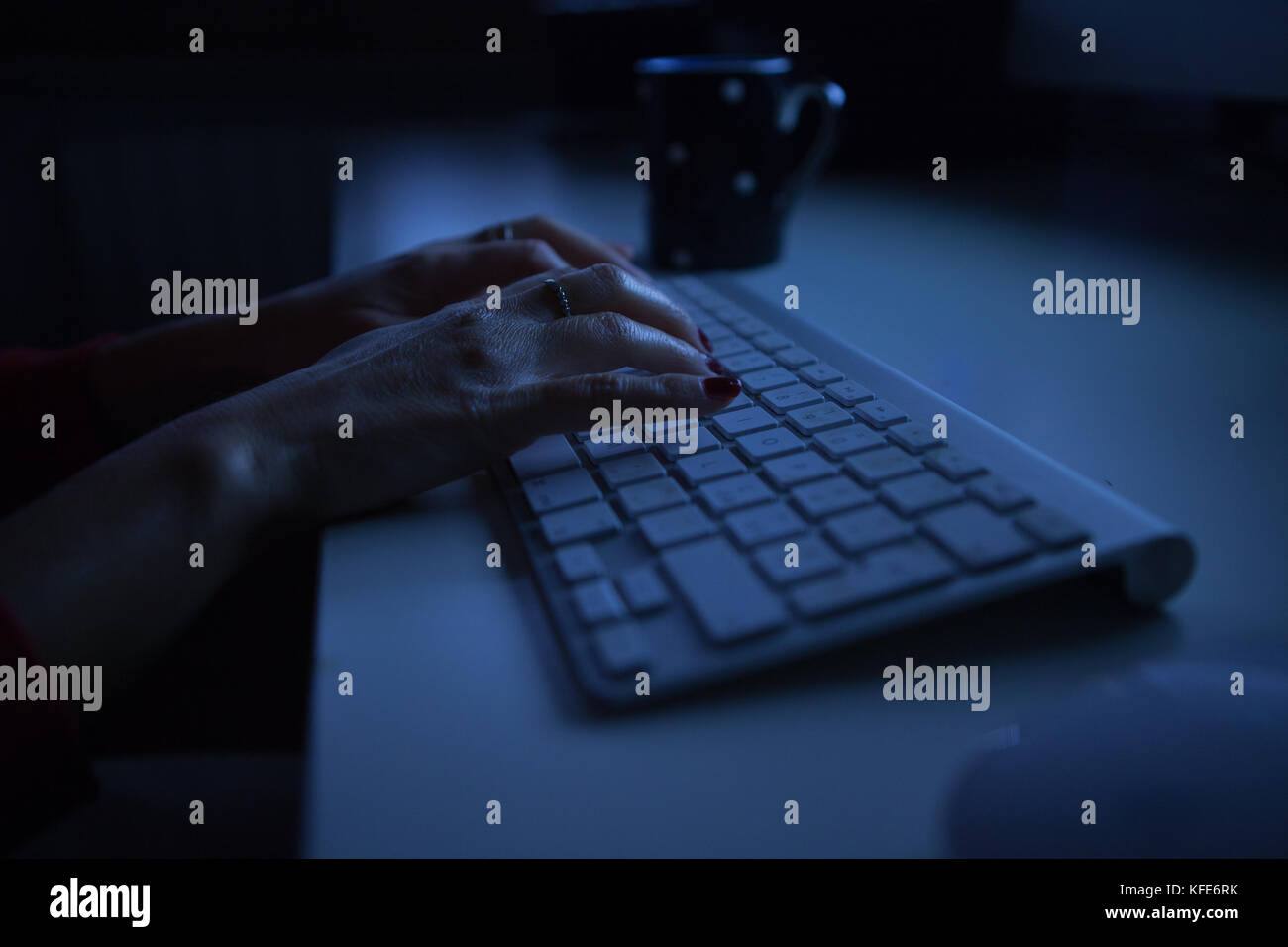 woman typing computer night light Stock Photo - Alamy