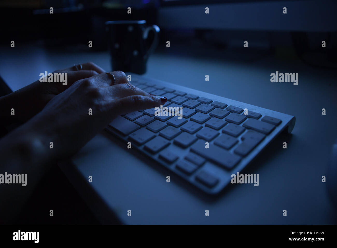woman typing computer night light Stock Photo - Alamy