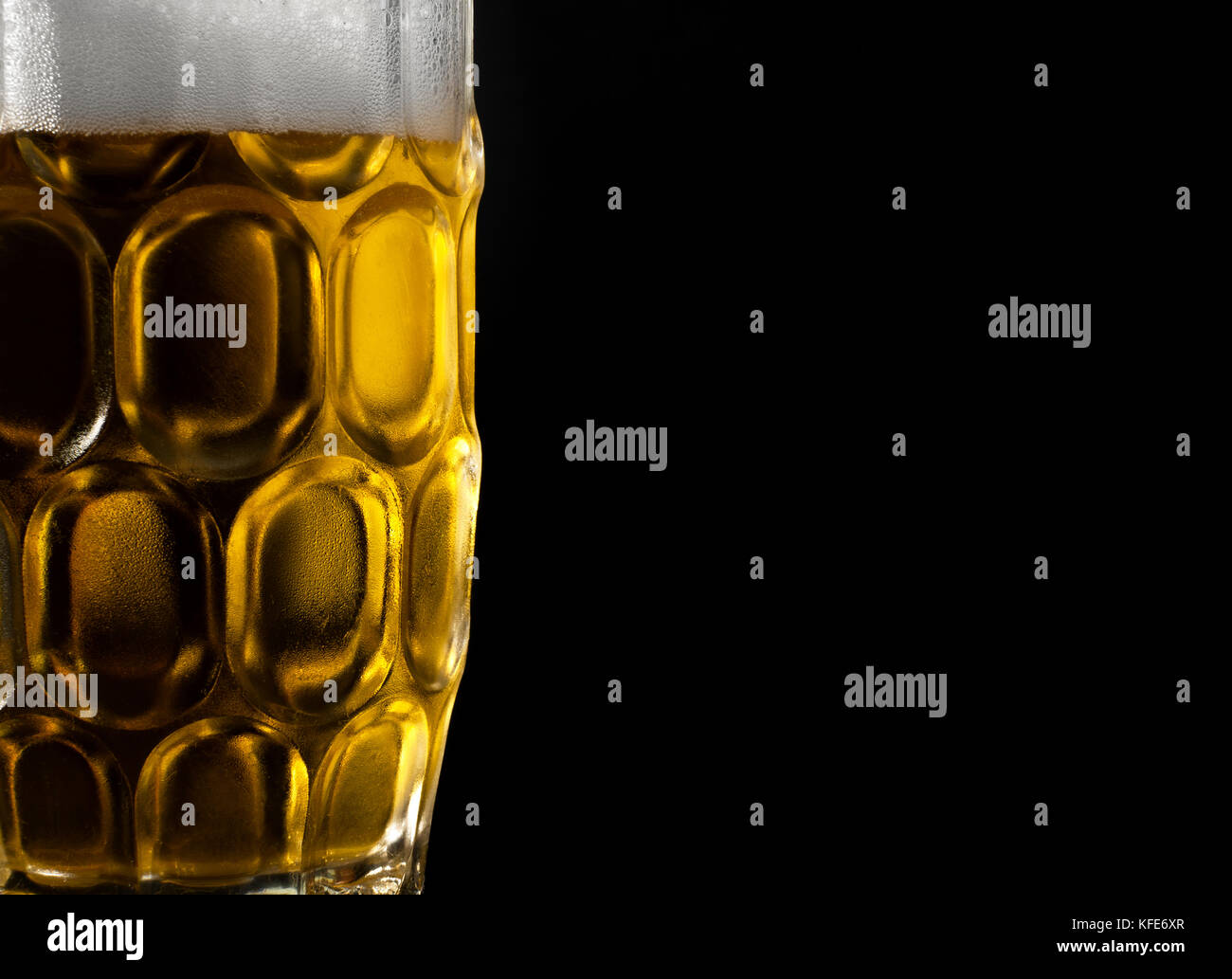 A pint of cold beer over a plain black backdrop Stock Photo - Alamy