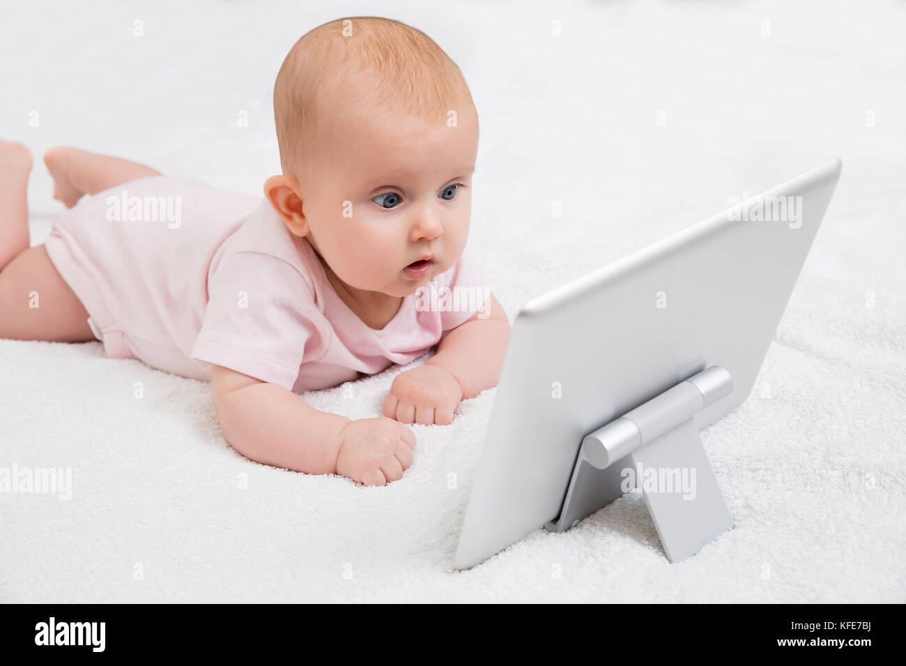 Cute Little Baby Looking At The Digital Tablet Stock Photo - Alamy