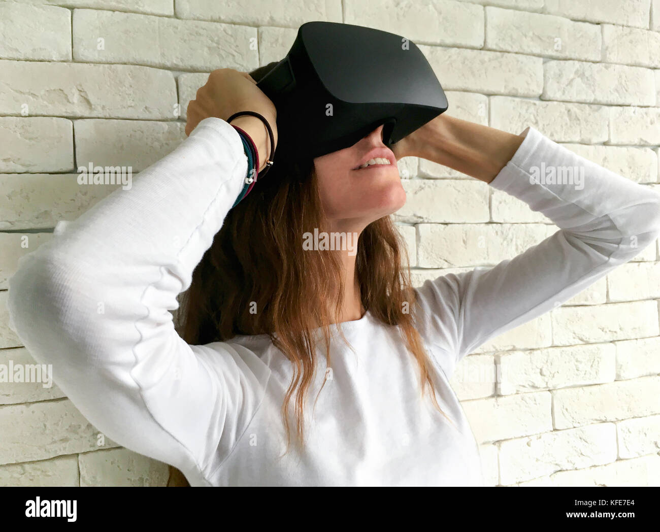 Young woman looking through virtual reality device Stock Photo - Alamy
