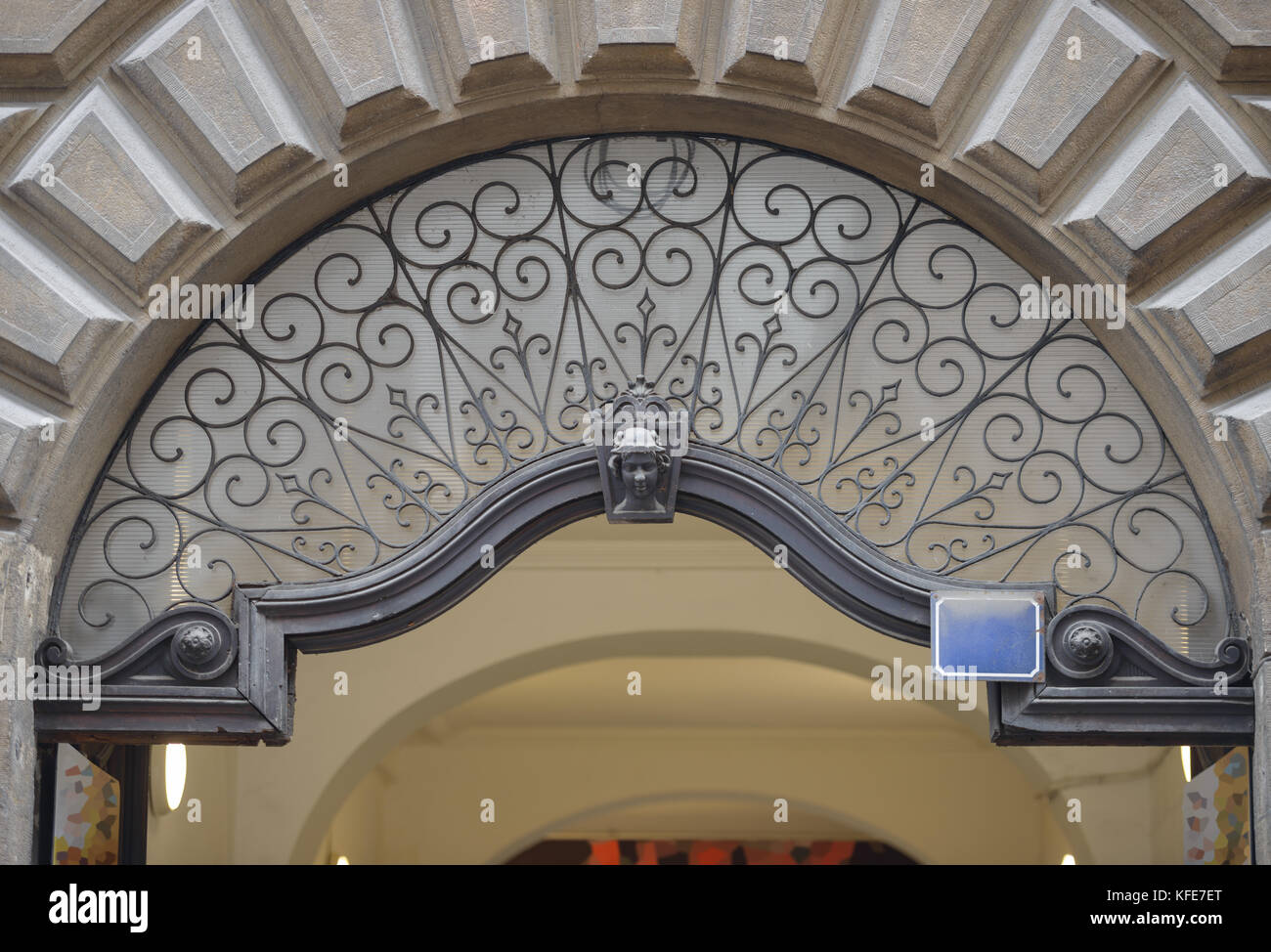 Close-up decorative glass and thin wrought pattern iron bars pediment ...