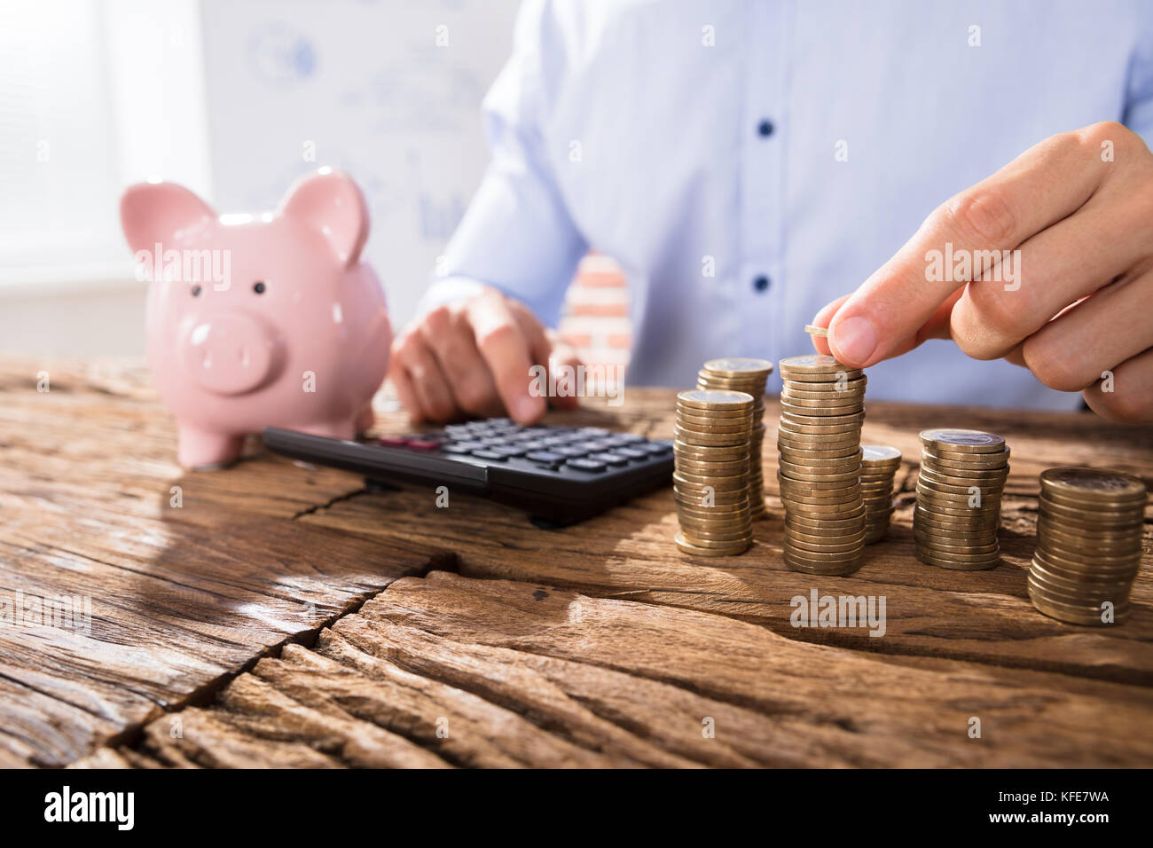 Close-up Of A Business Person Counting Coins Using Calculator With Pink ...
