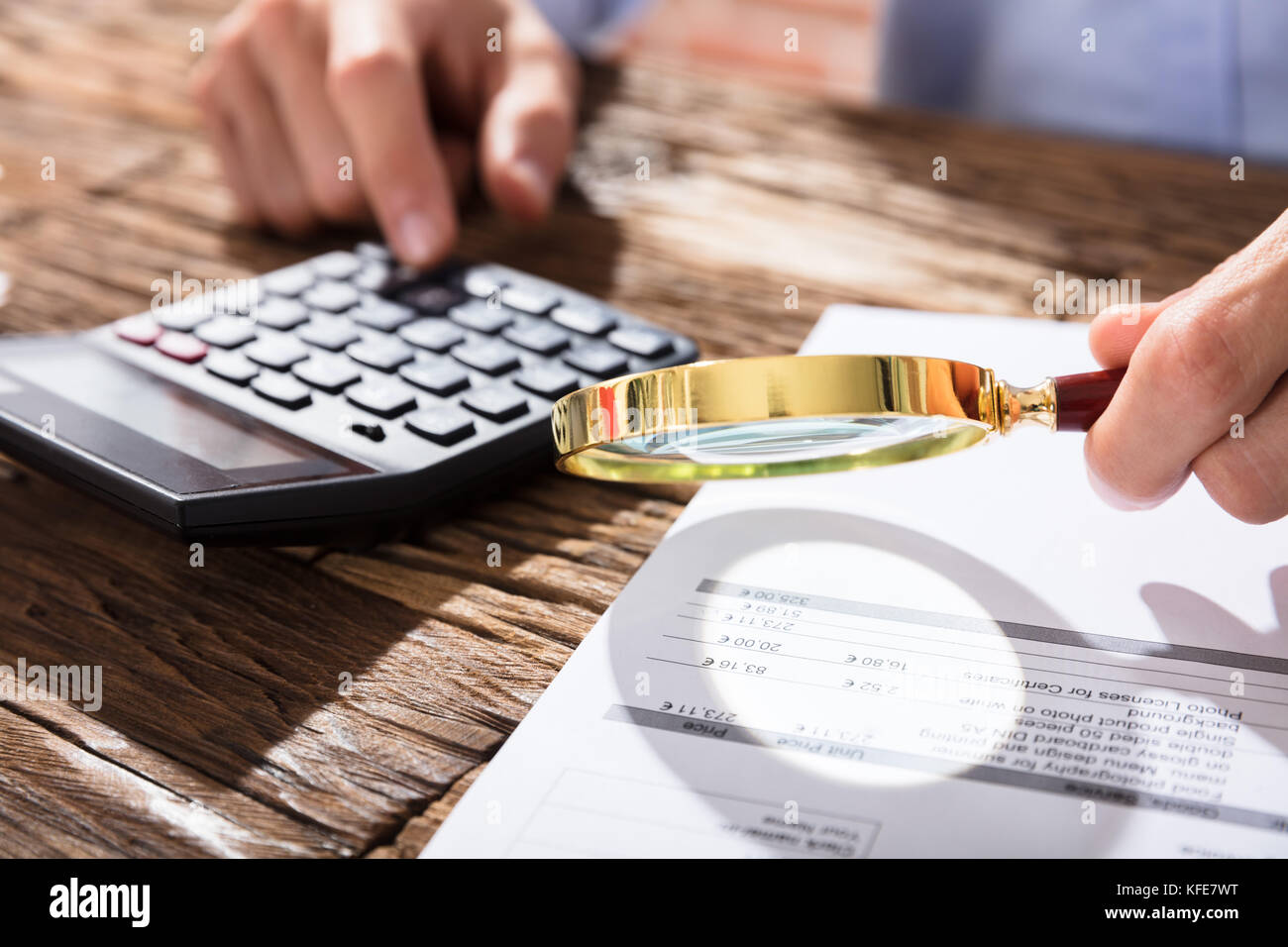 Close-up Of Accountant Using Magnifying Glass And Calculator While ...