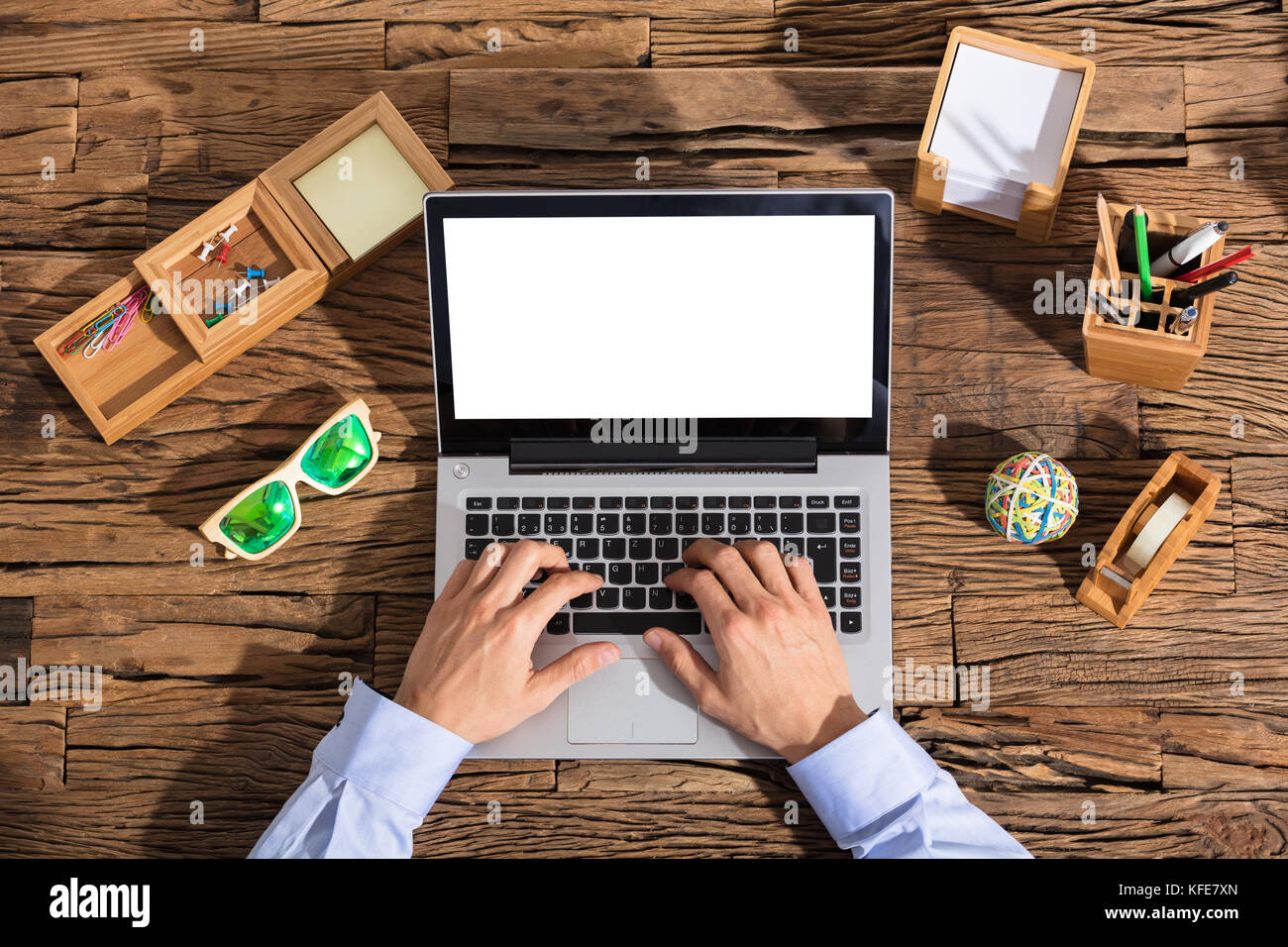 Business People Typing On Laptop At Workplace With Office Supplies Over ...