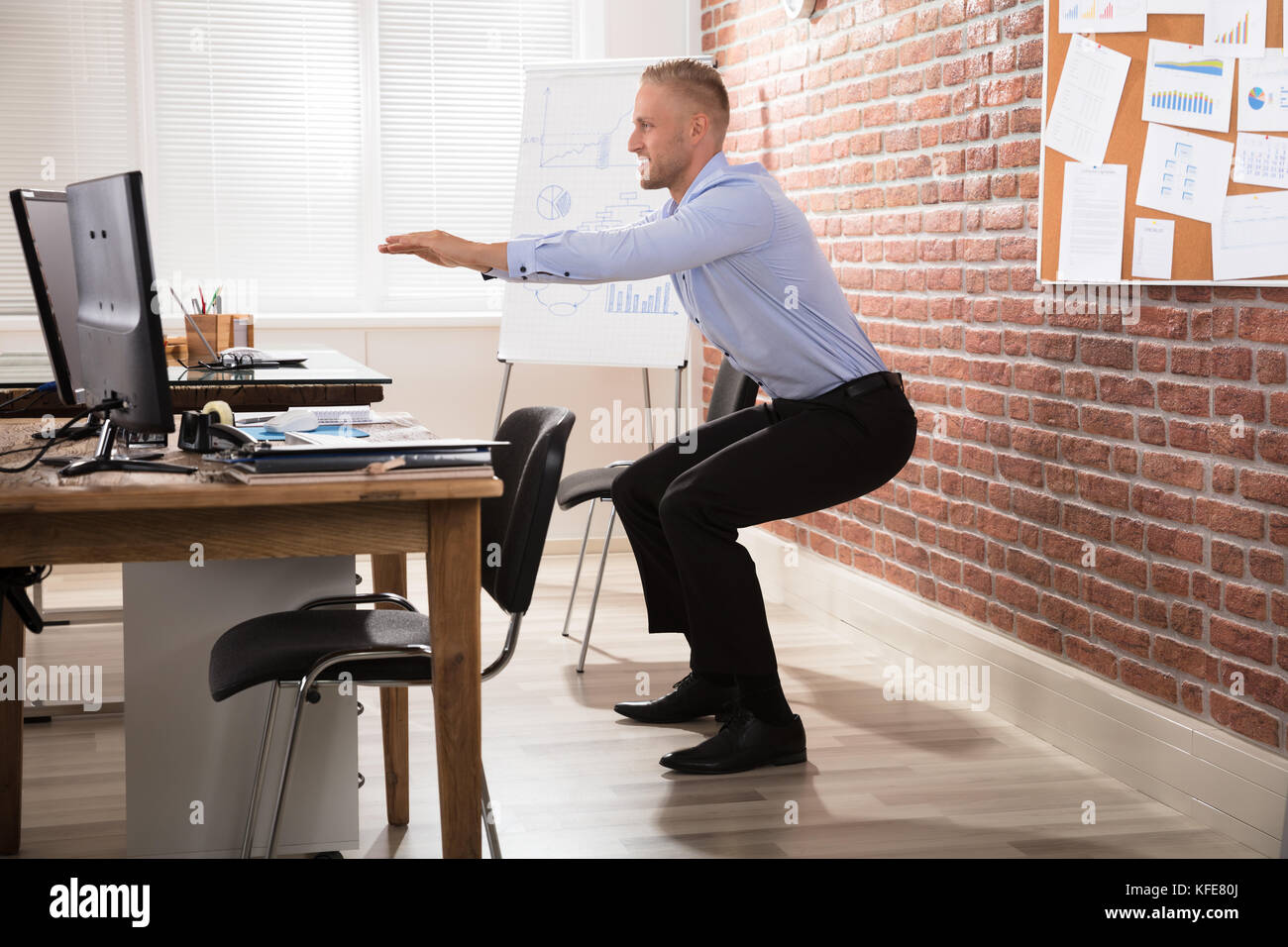 Happy Businessman Doing Exercise In Front Of Computer At Office Stock ...