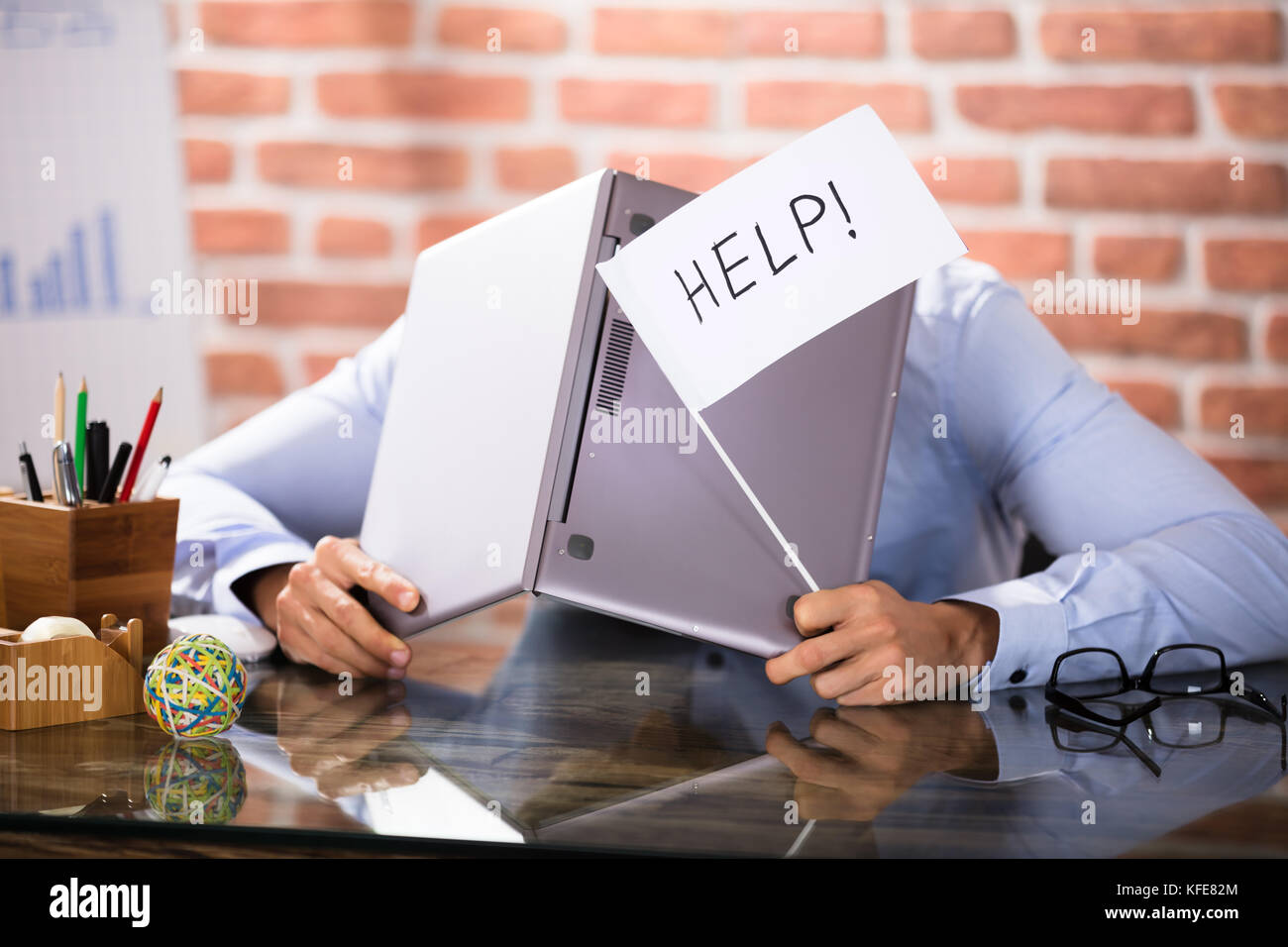Businessman Covering His Head With Laptop Holding Help Flag Over The ...