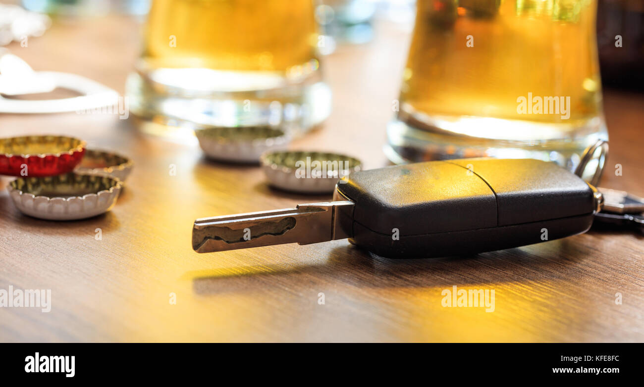 Drinking and driving concept. Car key on a wooden table, pub background ...
