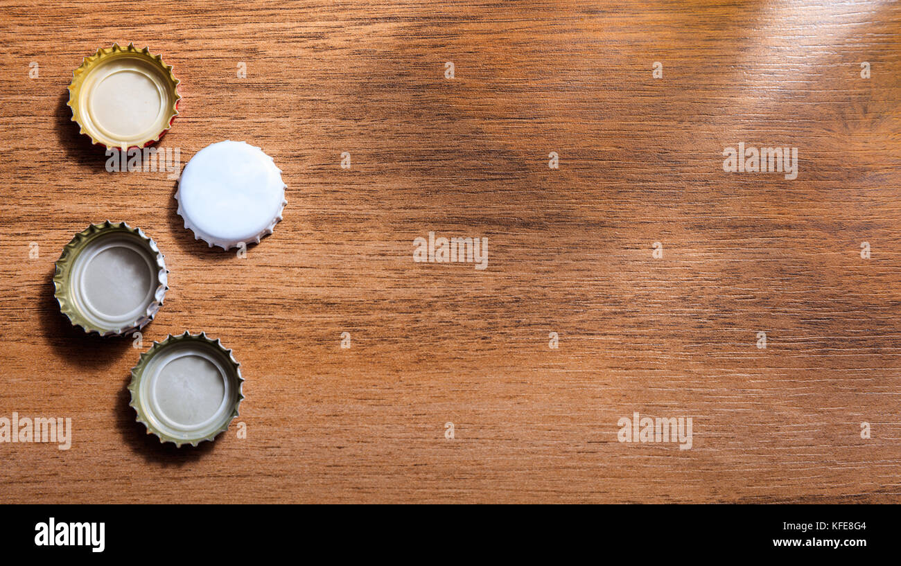 Beer caps on wooden background. Top view, copy space Stock Photo - Alamy