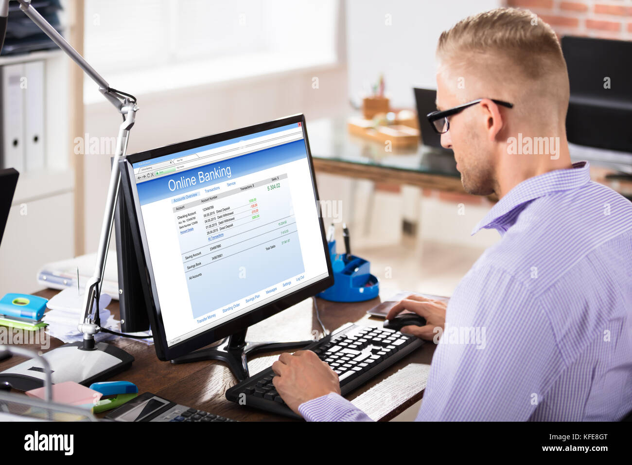 Young Businessman Wearing Spectacles Doing Online Banking On Computer ...