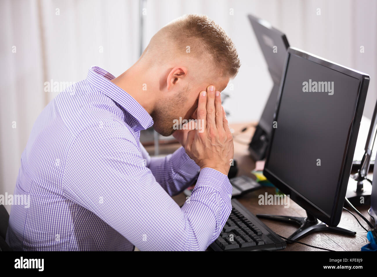 Businessman Suffering From Headache Sitting In Front Of Computer Stock ...