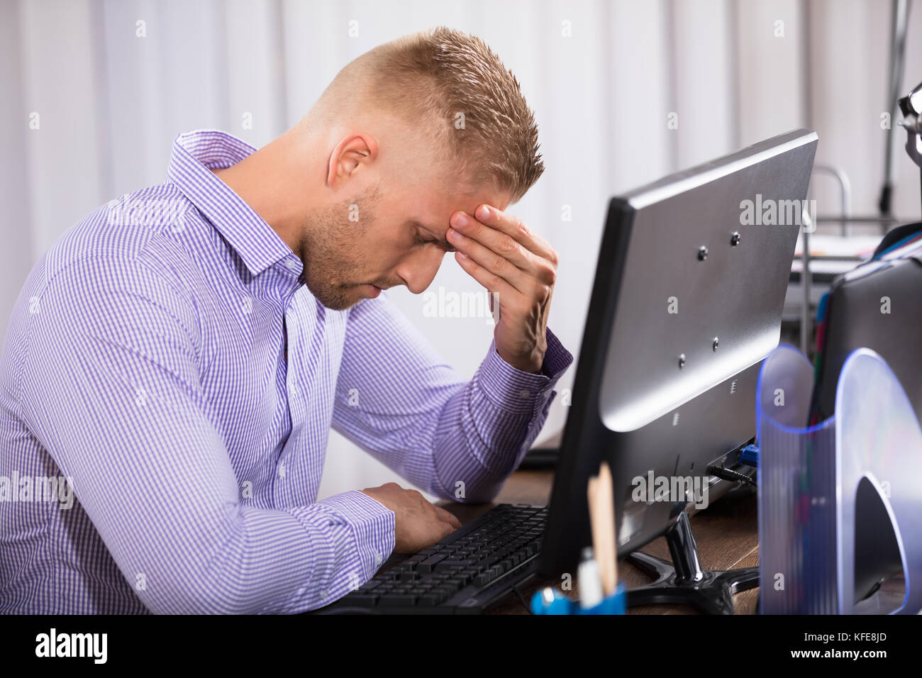 Businessman Suffering From Headache Sitting In Front Of Computer Stock ...