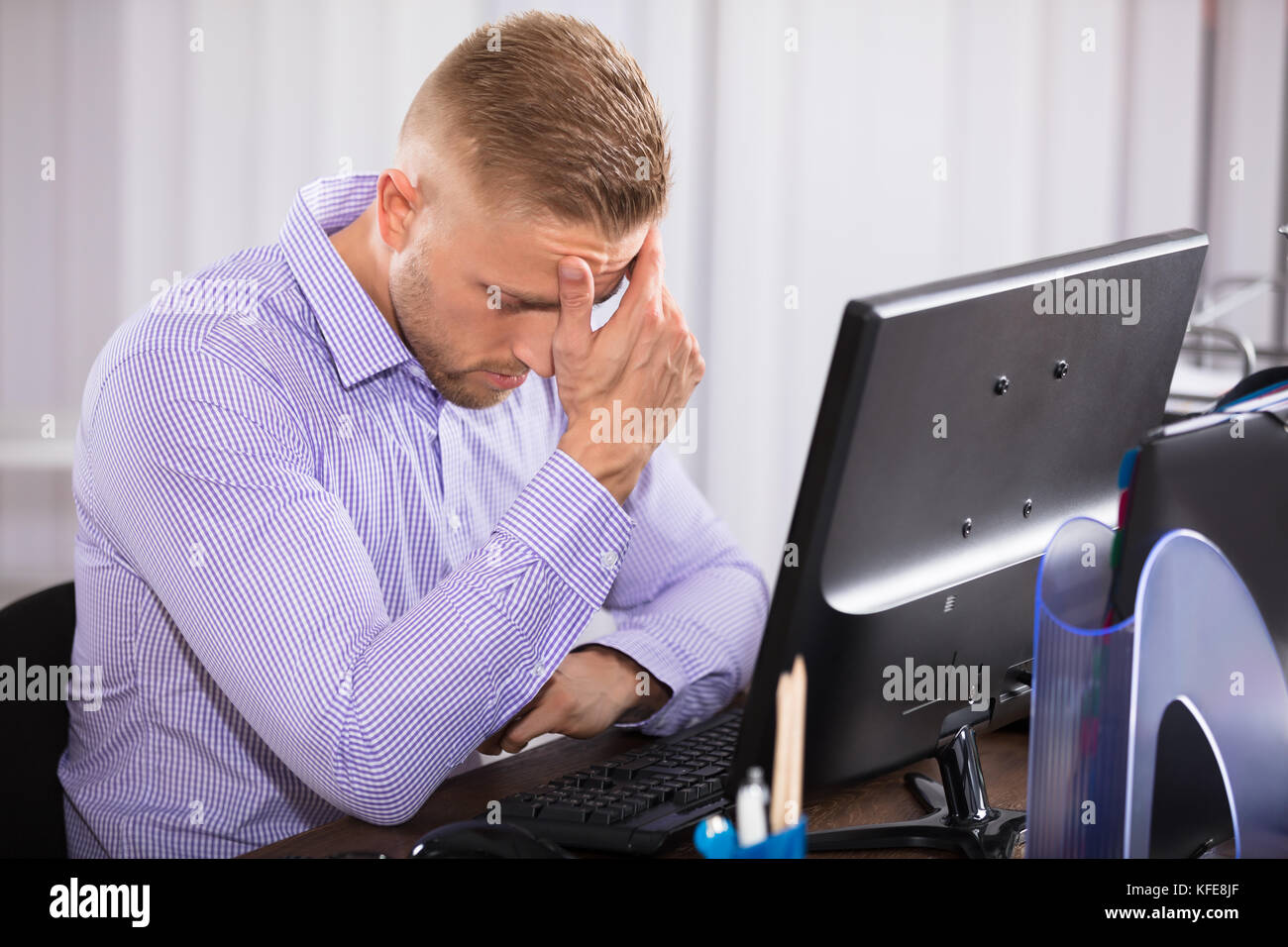 Businessman Suffering From Headache Sitting In Front Of Computer Stock ...