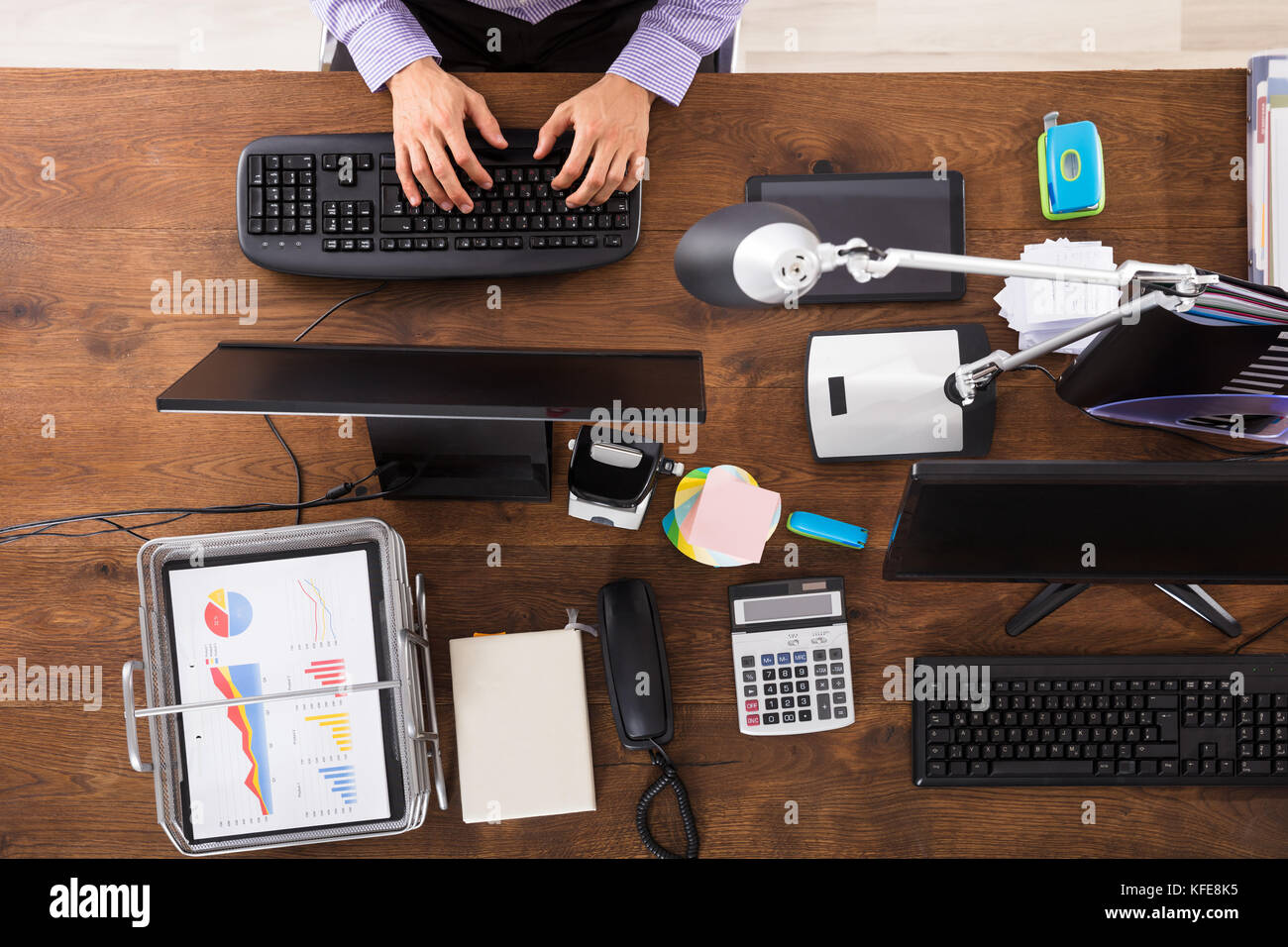 Elevated View Of Businessperson Working On Computer Over Wooden Desk ...
