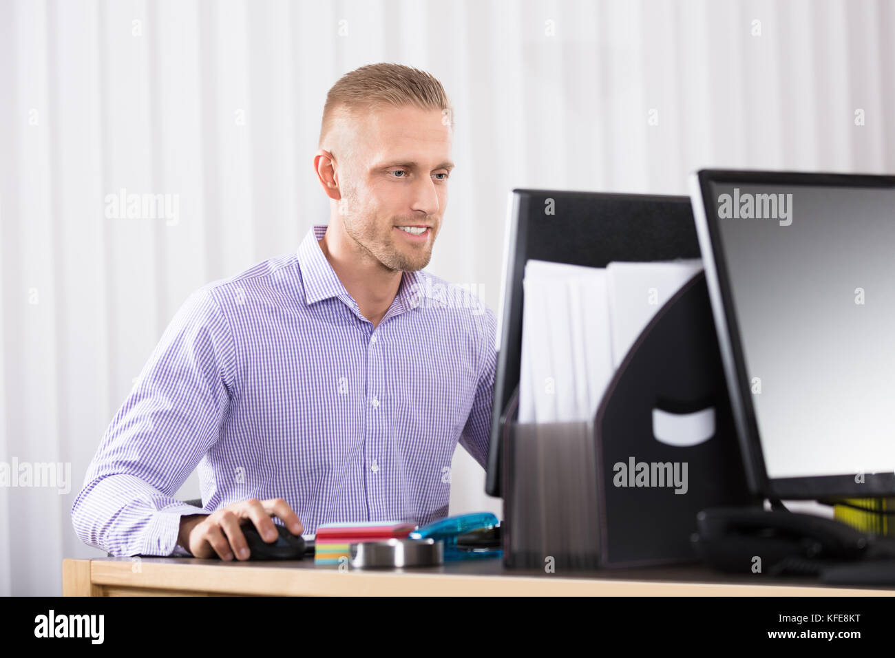 Close-up Of A Confident Young Businessman Using Computer At Workplace ...