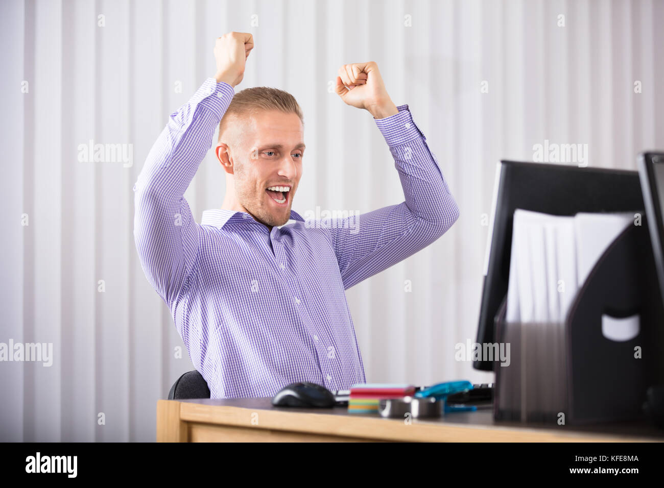 Successful Young Businessman Raising His Hands In Office Stock Photo ...