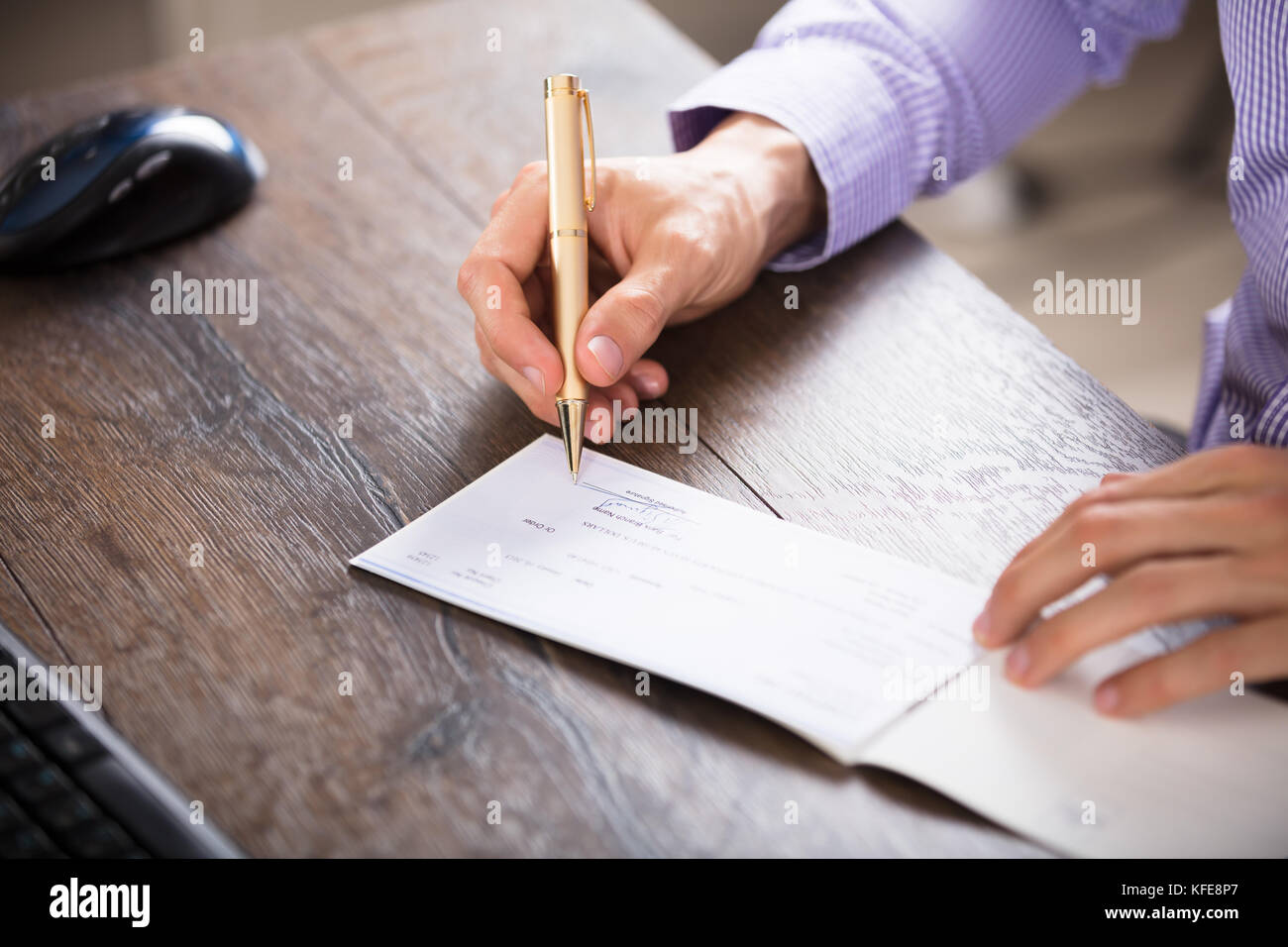 Close-up Of A Businessperson's Hand Signing Cheque In Office Stock ...