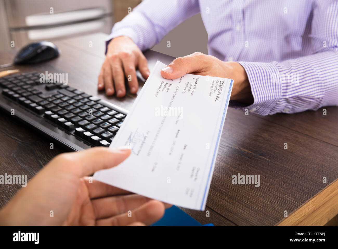 Close-up Of A Businessman Giving Cheque To Her Colleague At Workplace ...