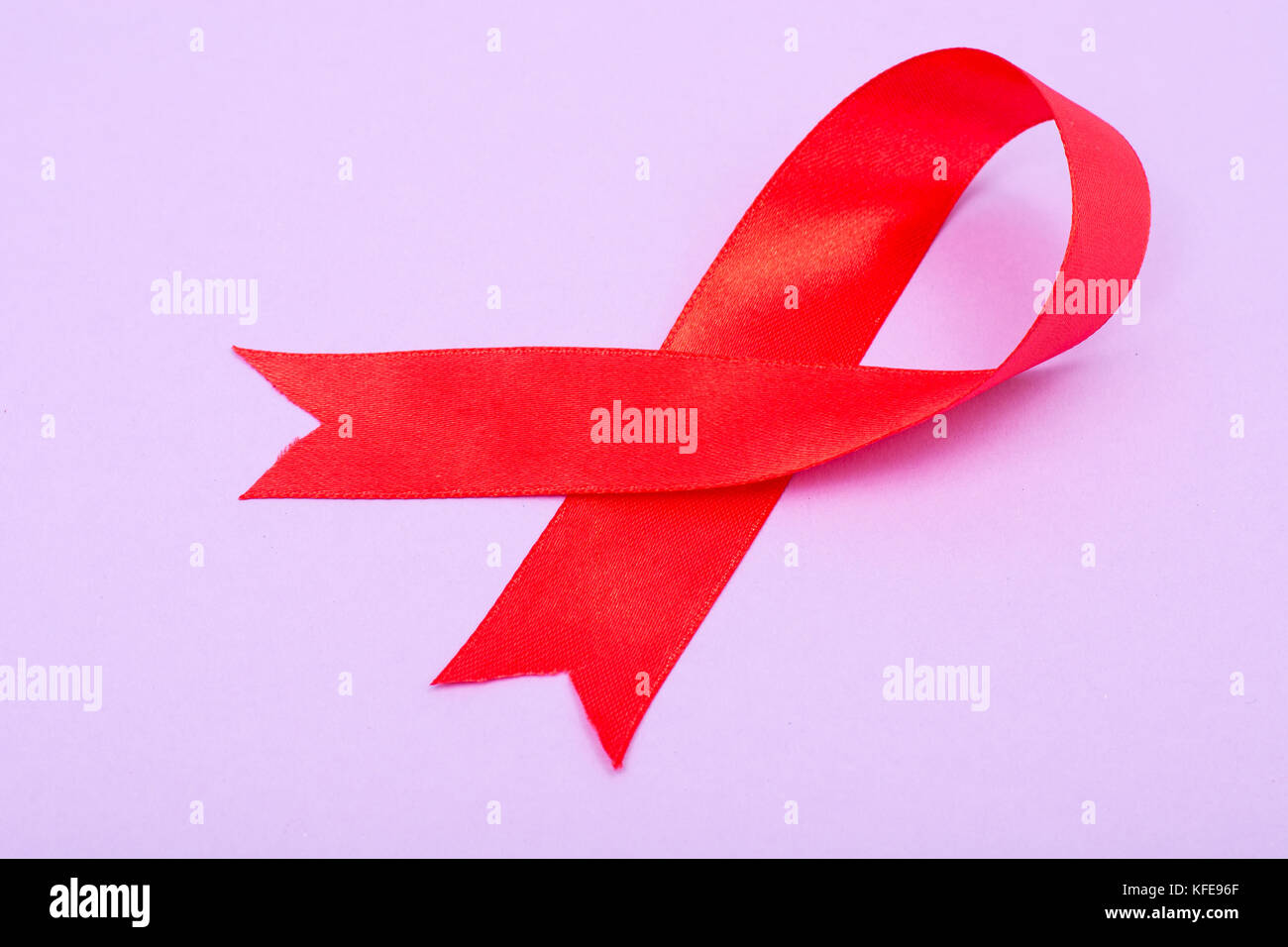 Red ribbon-symbol of awareness about AIDS Stock Photo - Alamy