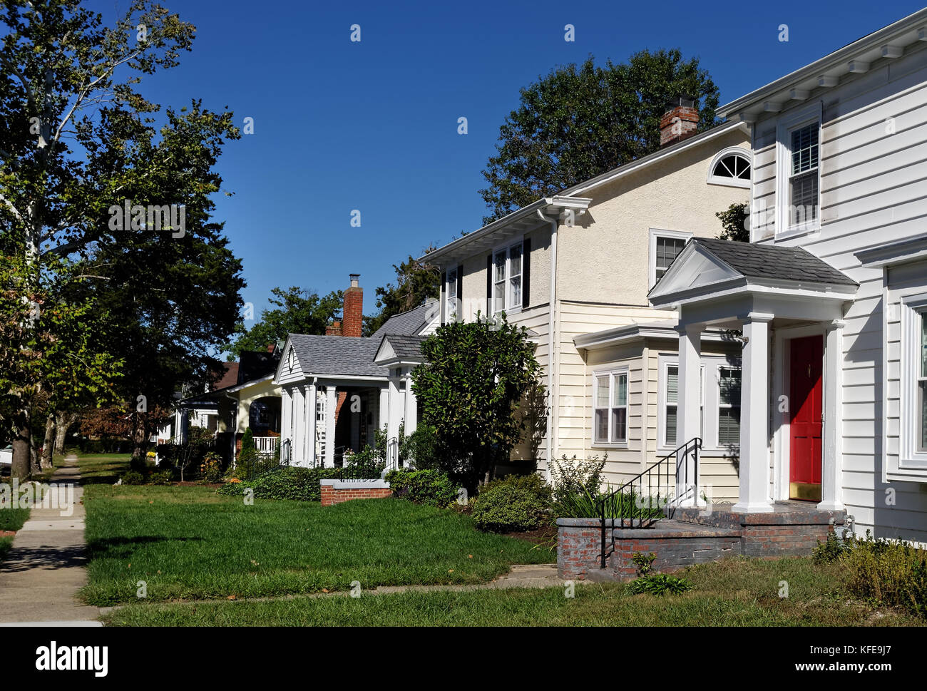 Neighborhood city block of homes with blue sky Stock Photo - Alamy