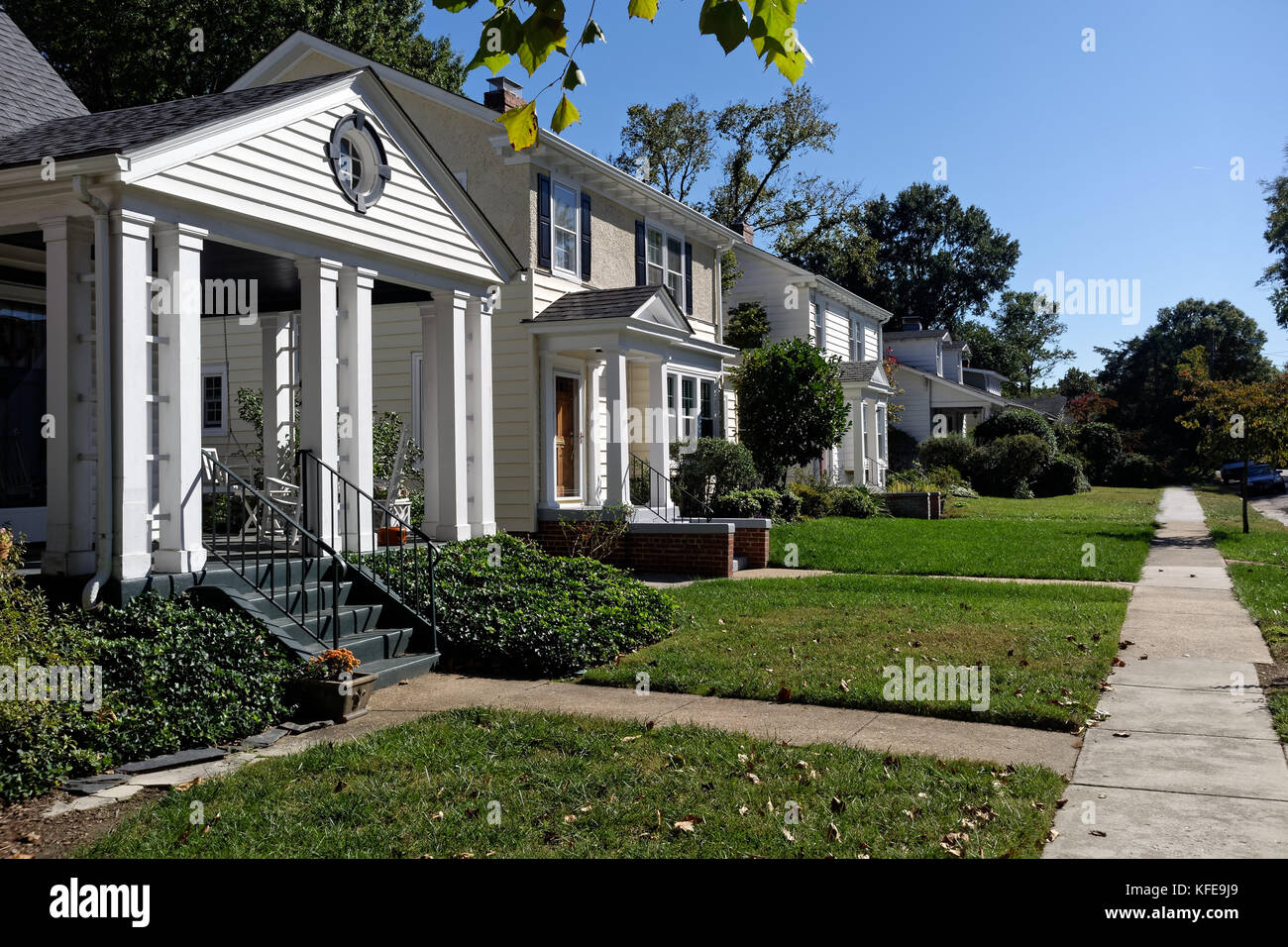 Neighborhood city block of homes with blue sky Stock Photo - Alamy