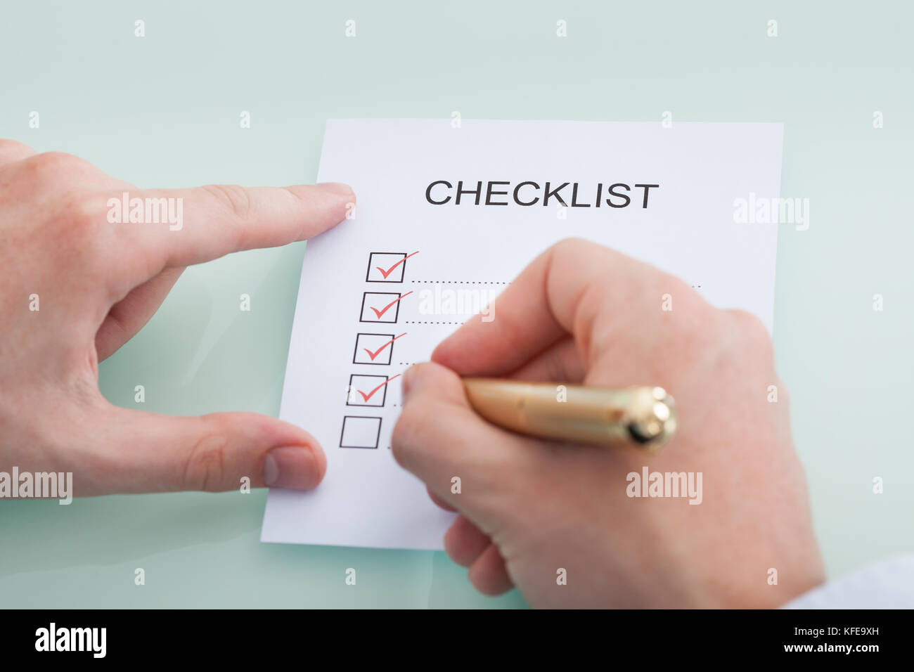 Cropped image of businessman preparing checklist at office desk Stock ...