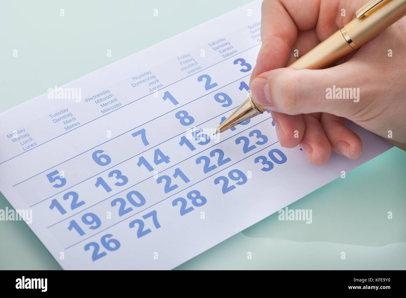 Closeup of man's hand marking date 15 on calendar Stock Photo - Alamy