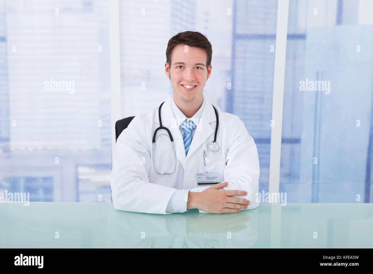 Doctor sitting at desk hi-res stock photography and images - Alamy