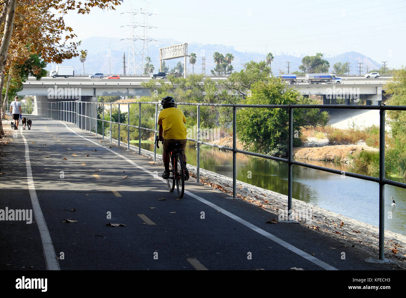 Person cycling along the LA River walking and bike path in Frogtown in ...